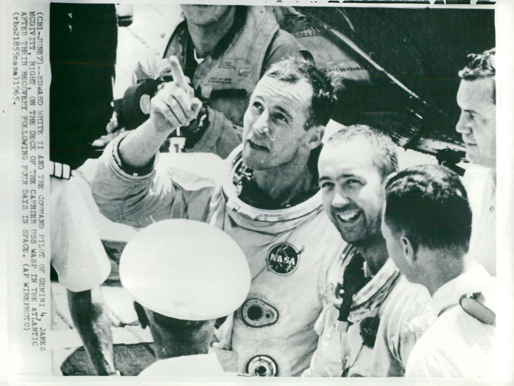 The astronauts James MccDivitt and Edward White II aboard the USS WASP