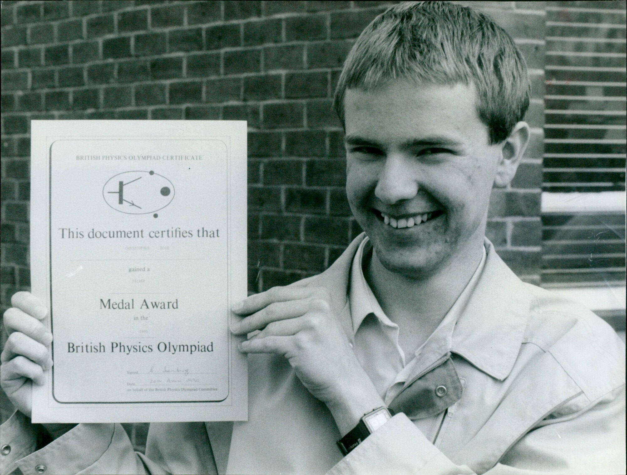 Christopher Dove, 17, is presented with a certificate for his silver a