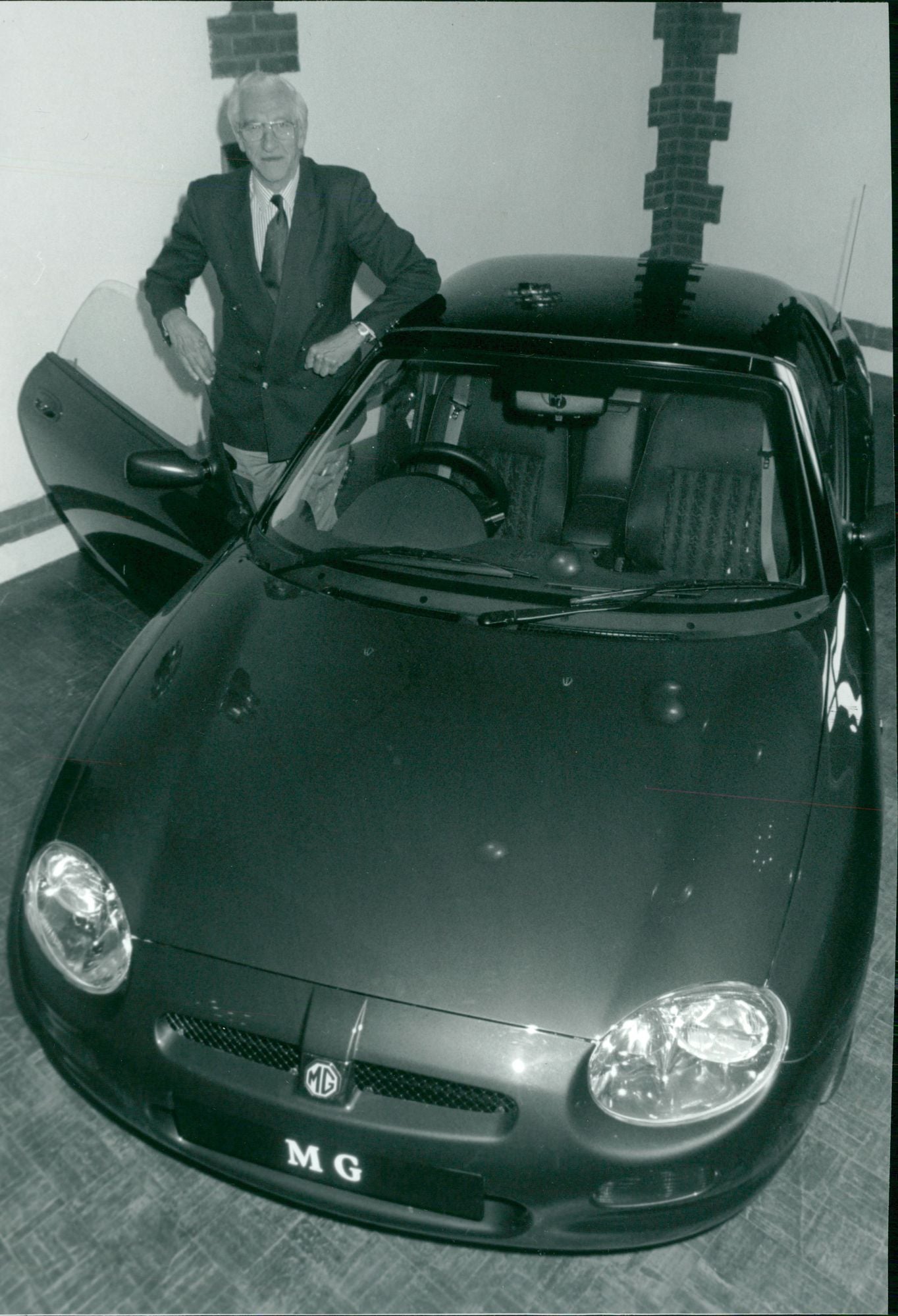 BBC TV commentator Raymond Baxter with the new MG sports car in Kings
