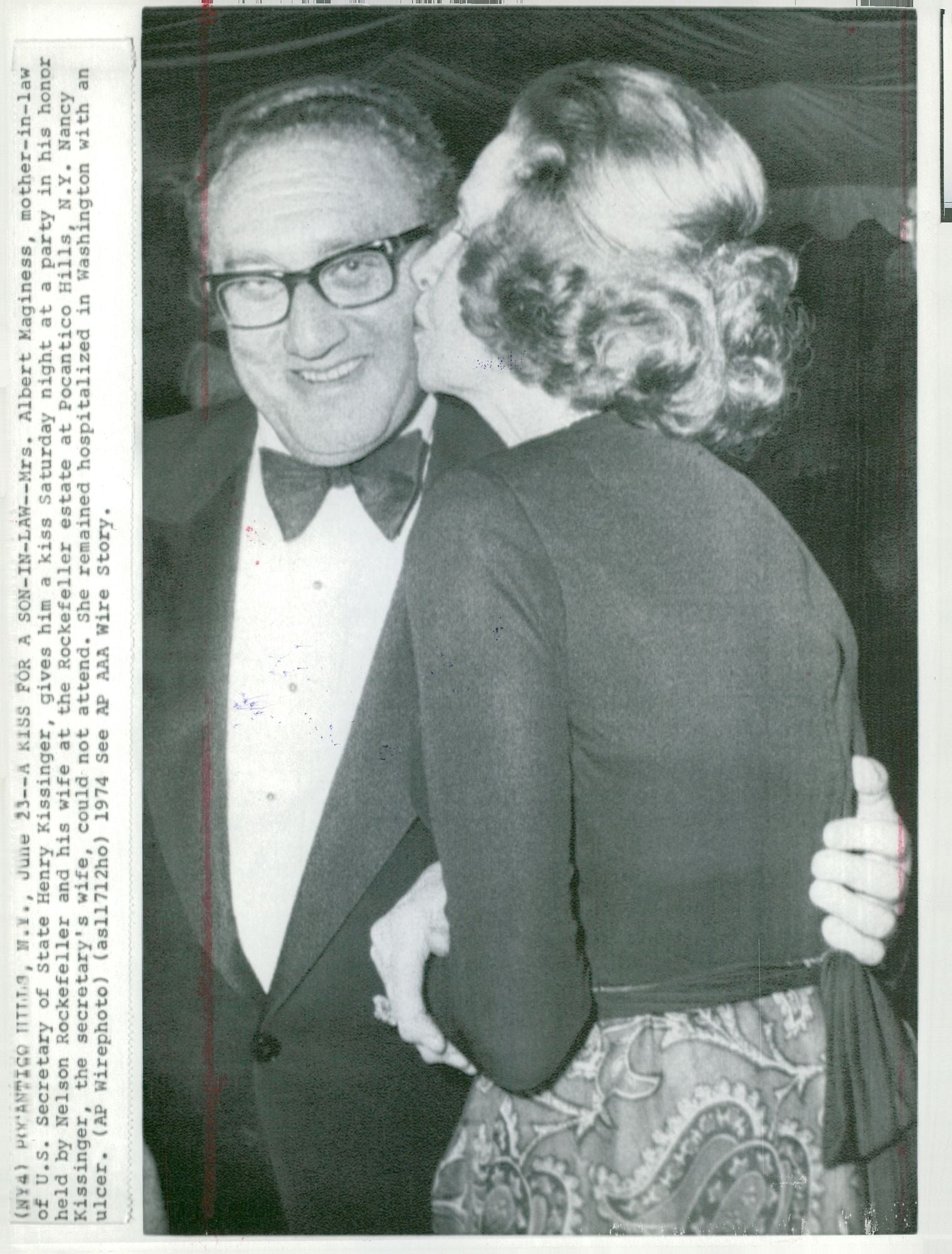 Henry Kissinger gets a kiss on the cheek by her mother-in-law, Agnes M