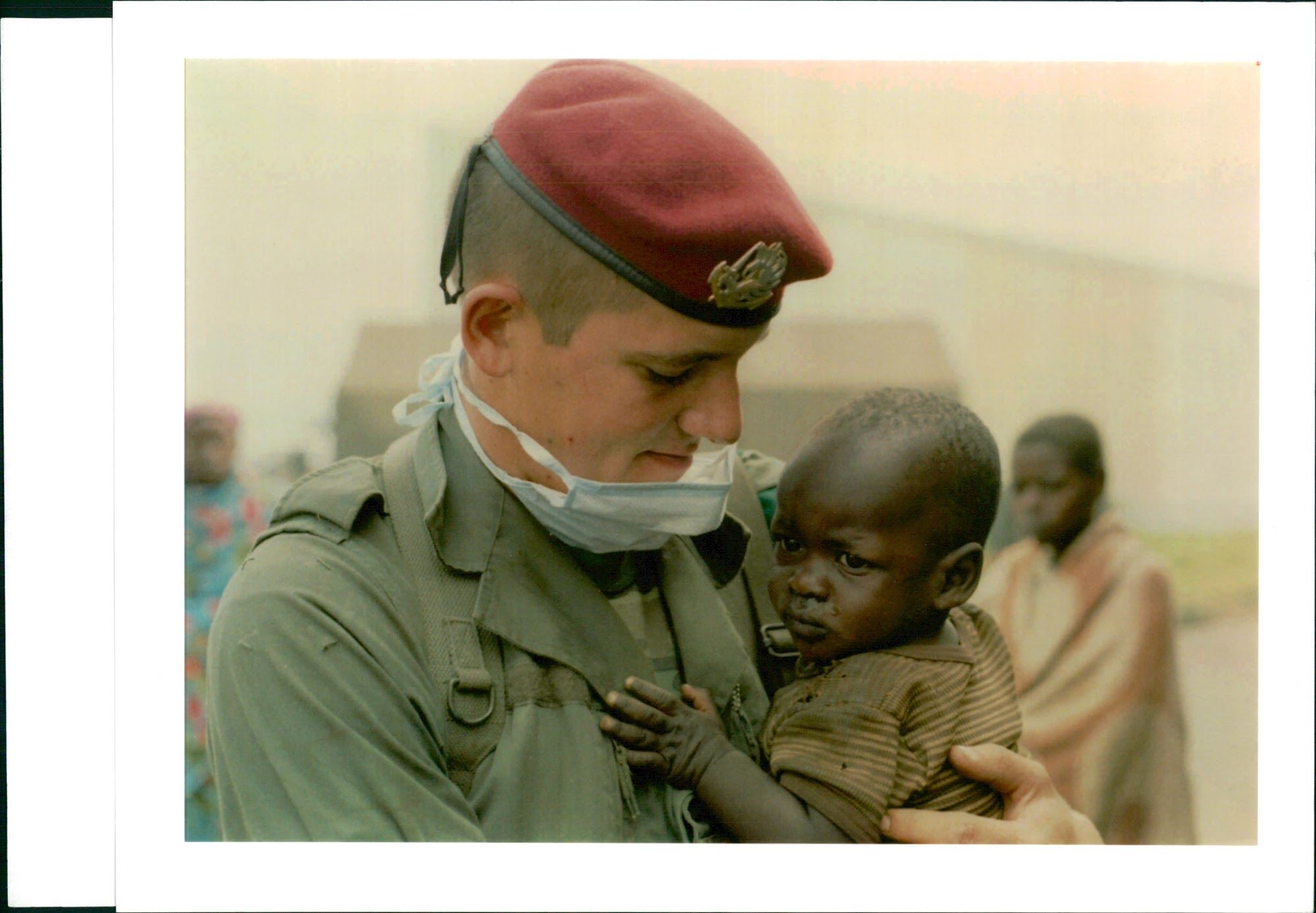 The Rwandan War: French soldier cradles an orphan rwandan. - Vintage P