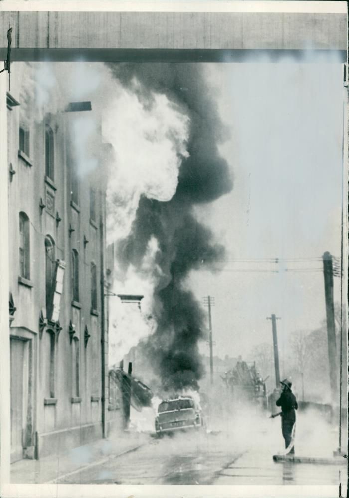 civil righh riots:a parked car falls victim. - Vintage Photograph