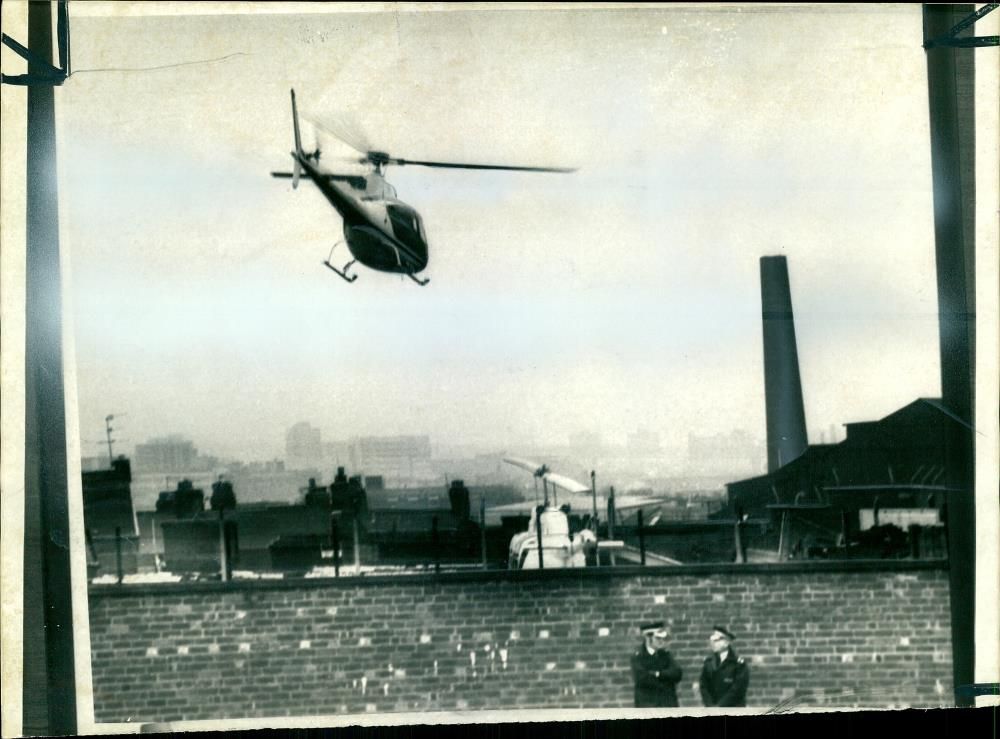 Crossing the picket line a helicopter flying. - Vintage Photograph