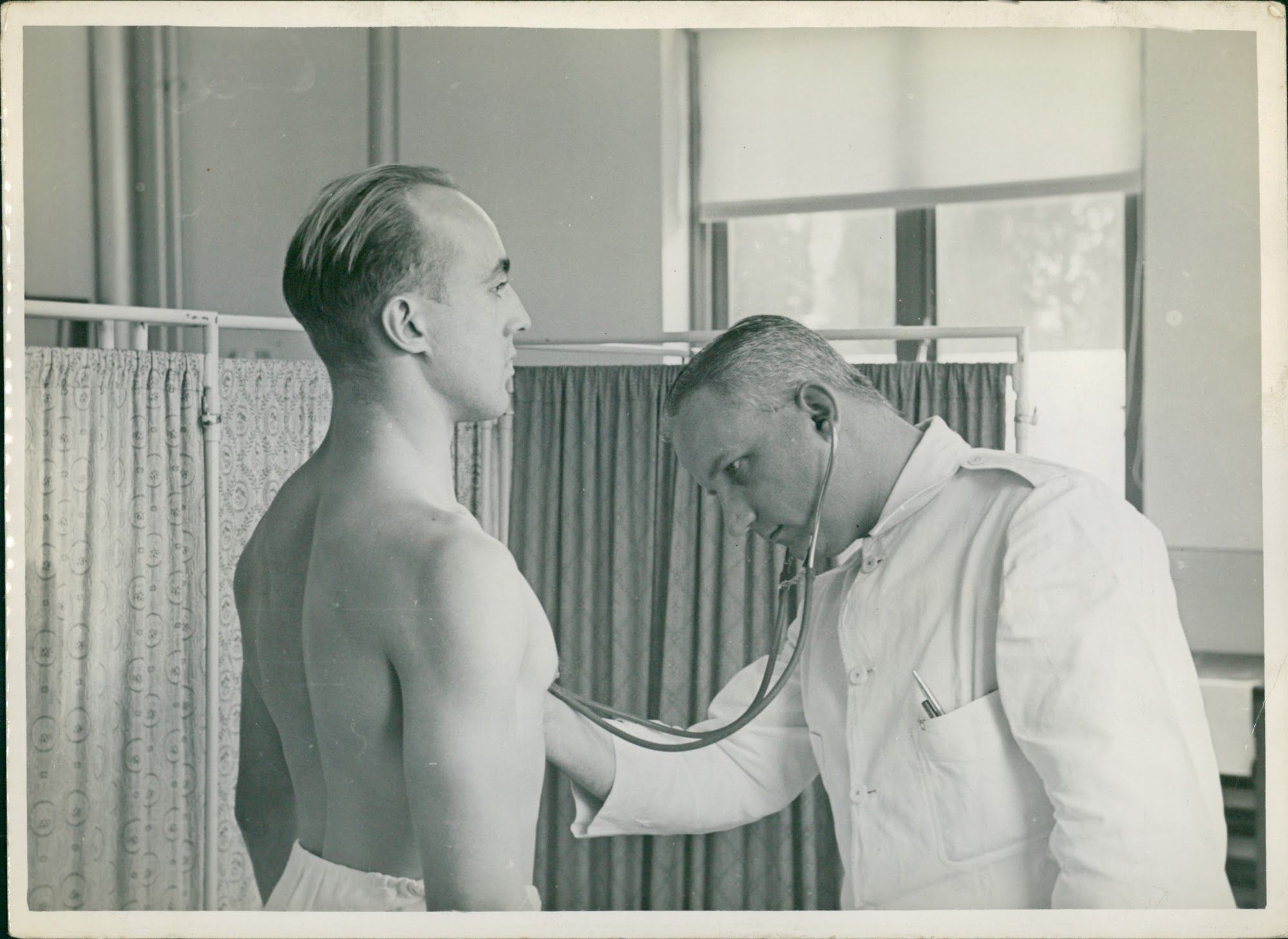 Medical examination of a soldier by a military doctor - Vintage Photog