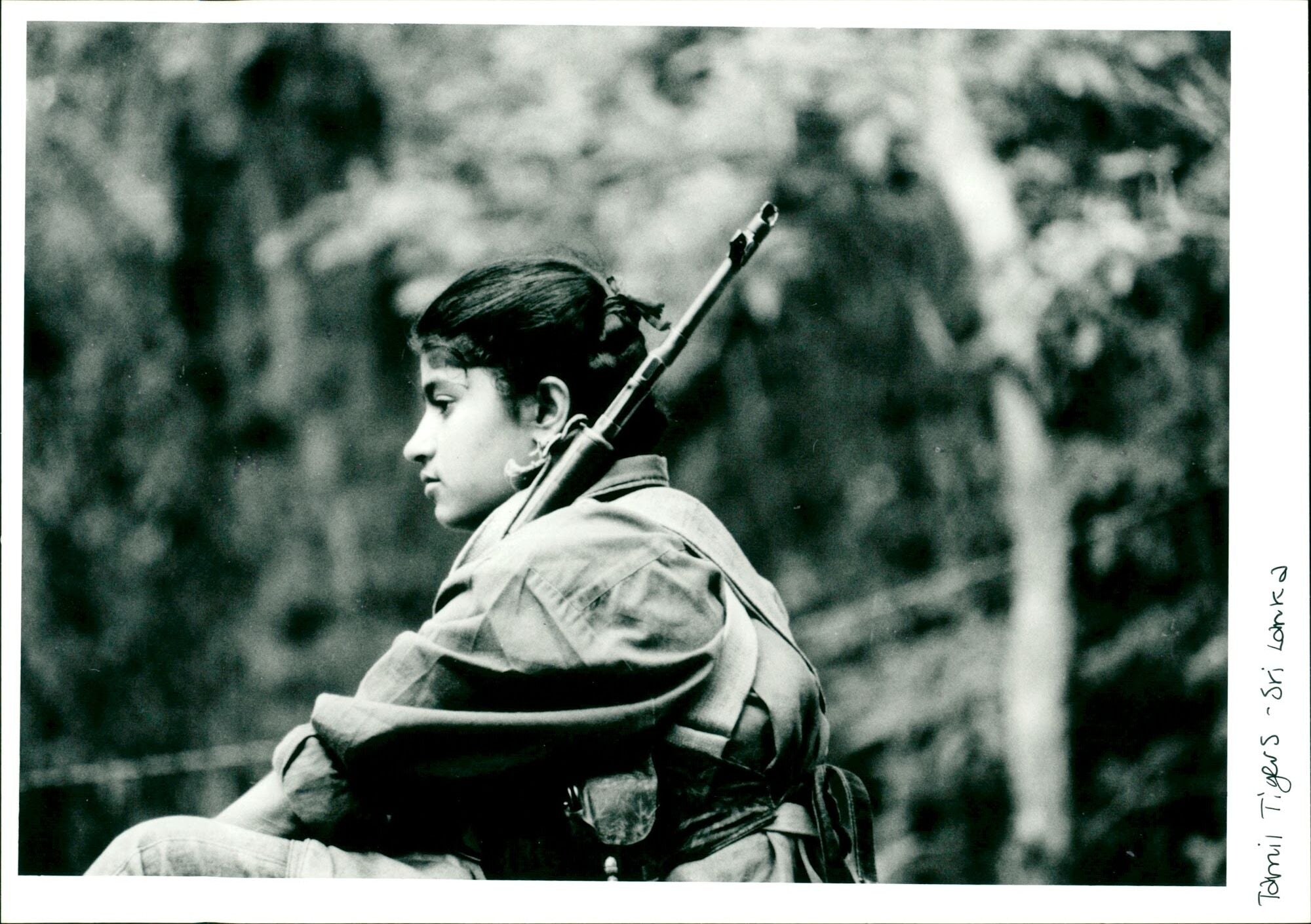A group of Tamil Tiger fighters pose with their weapons in Sri Lanka.