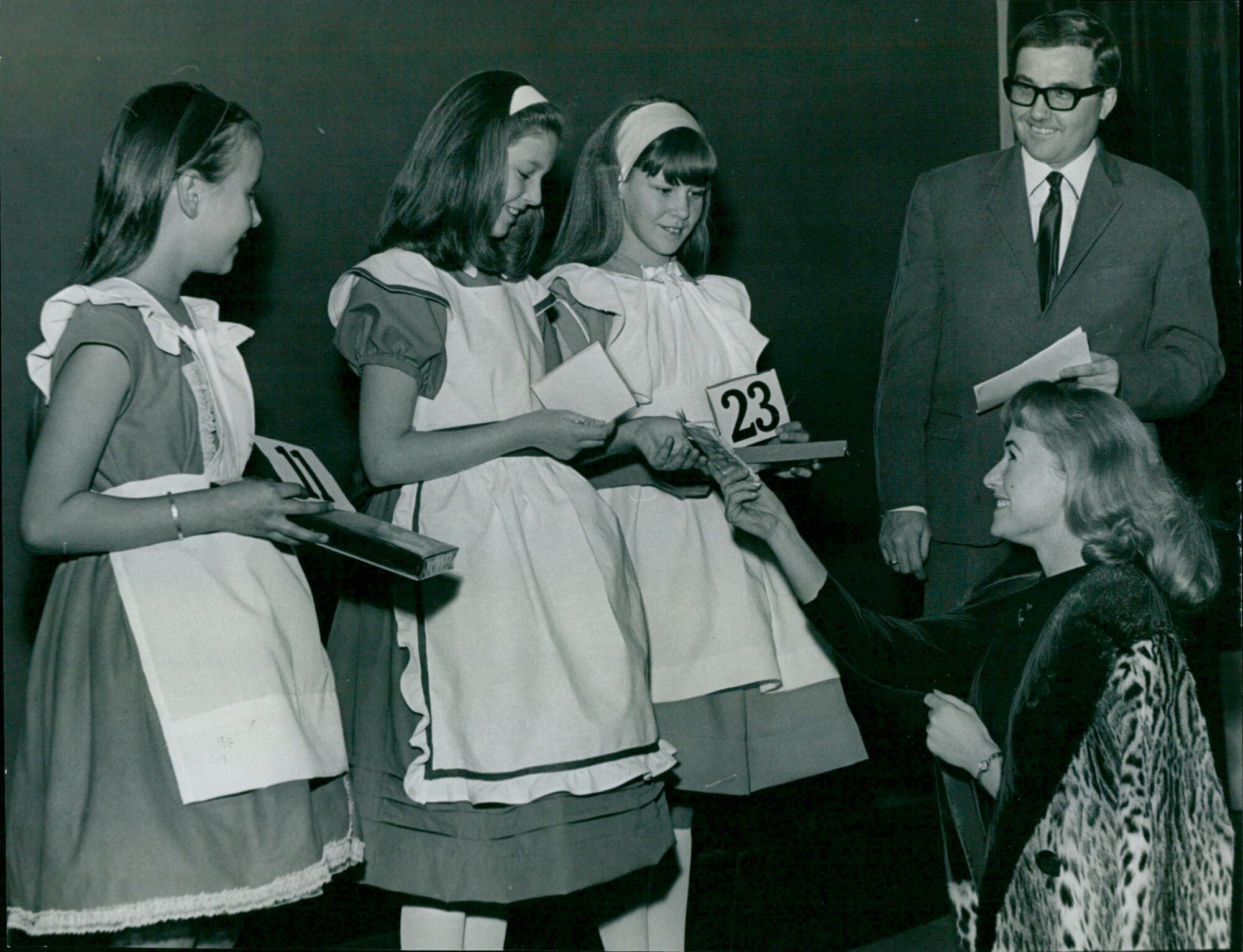 Actress Erica Yorke presents a prize to 11-year-old Pamela James at Co