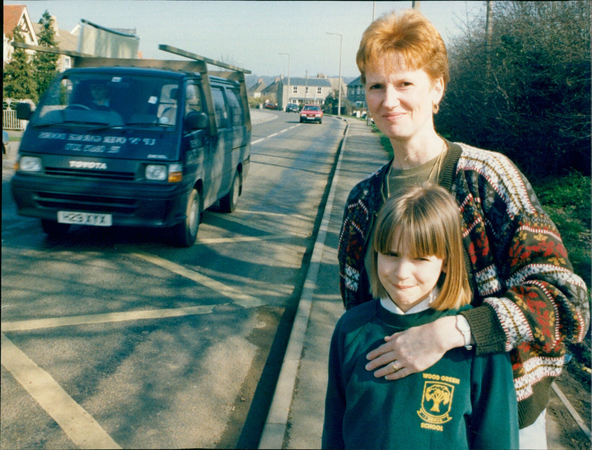 Mrs. Pay Young and her daughter Vicky triumphantly stand at a newly in
