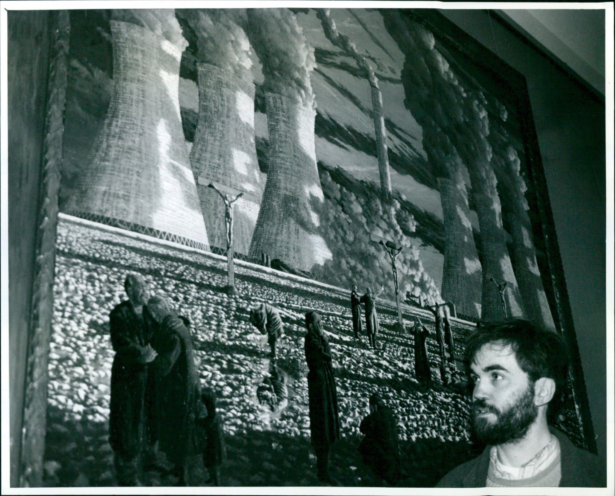 Artist Roger Wagner poses with his painting of the Crucifixion in fron