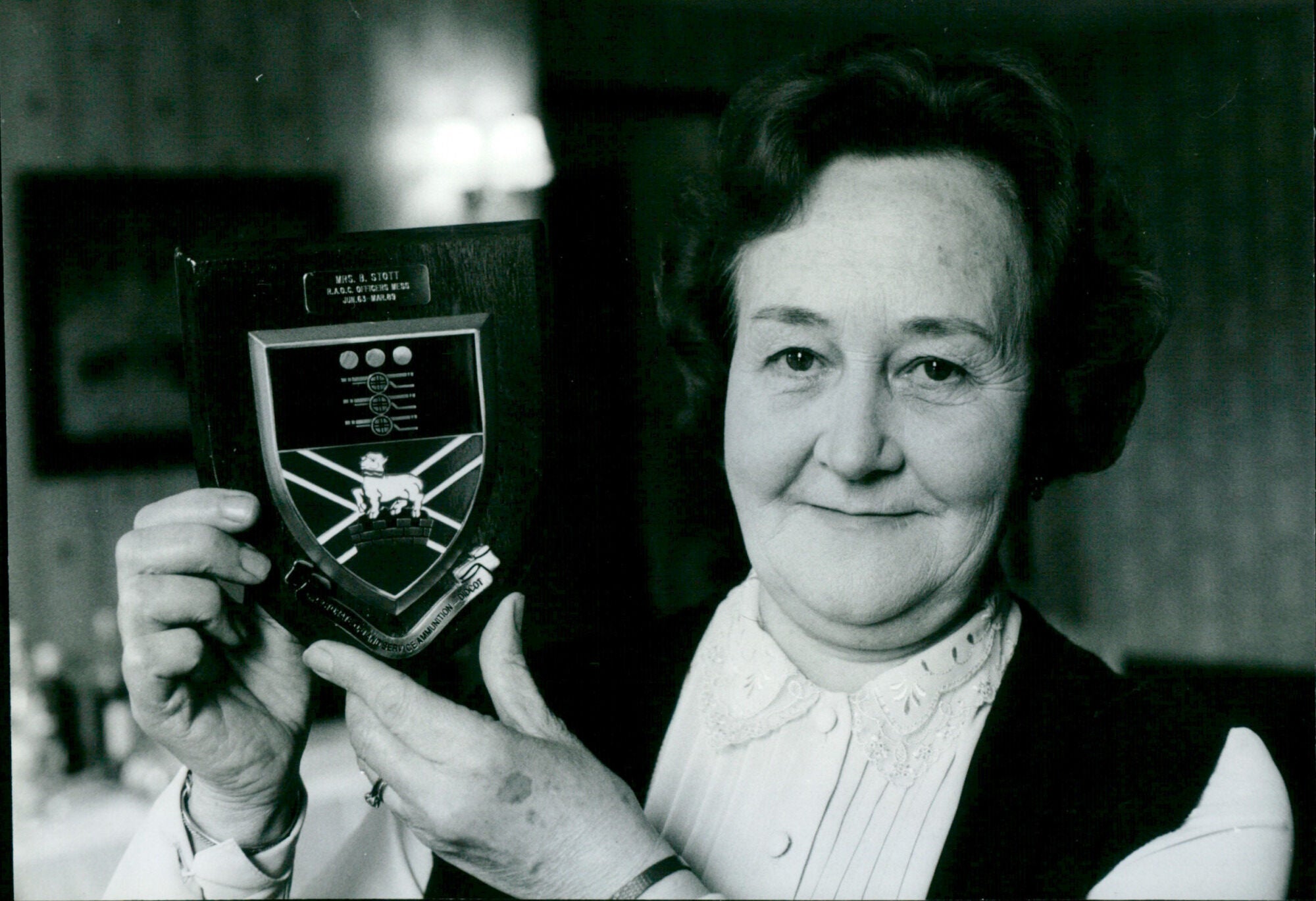 Mrs. Barbara Stott receiving a commemorative plaque for 25 years of se