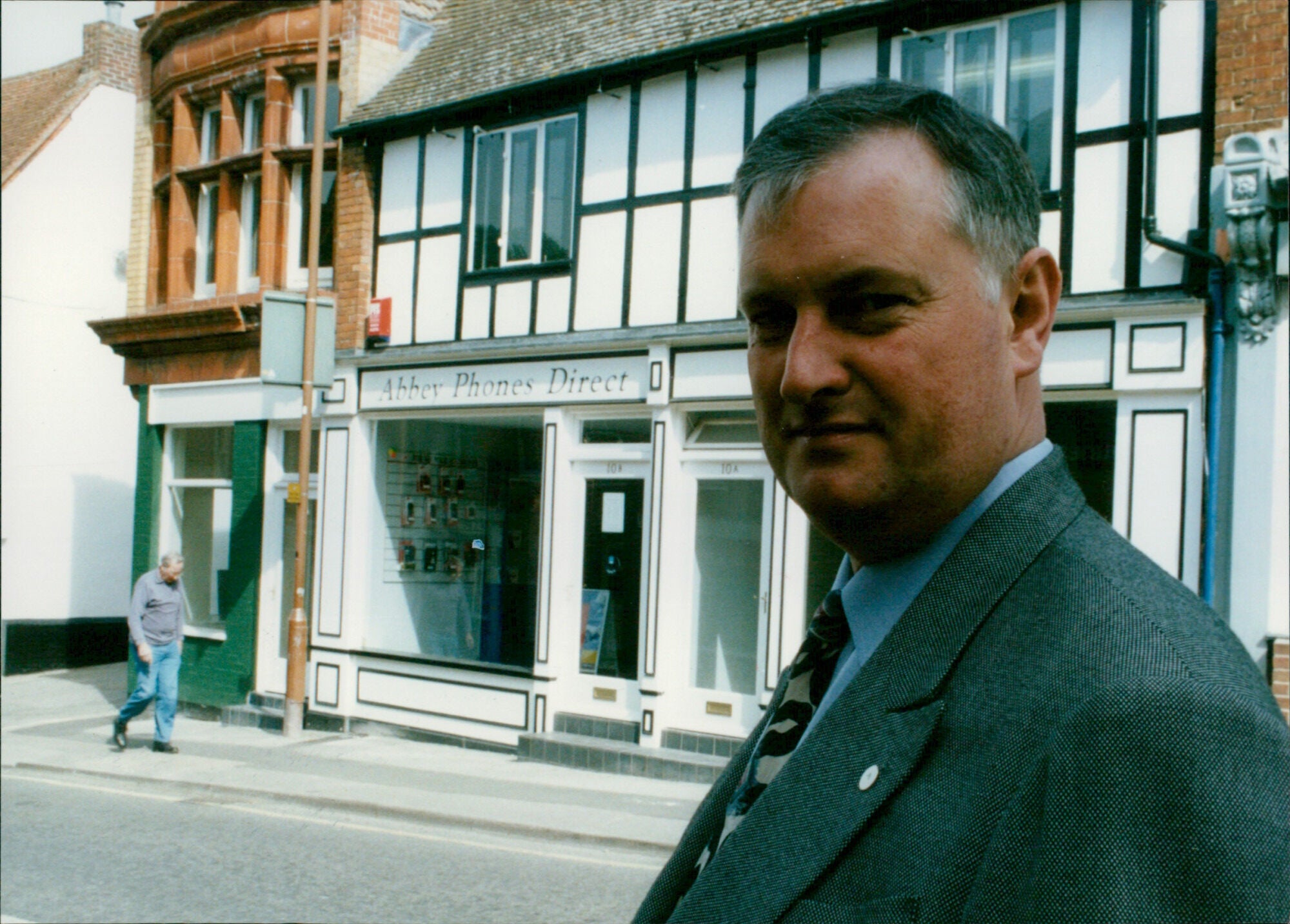 Bob Sturgess stands outside the four shops he owns in Wantage, England