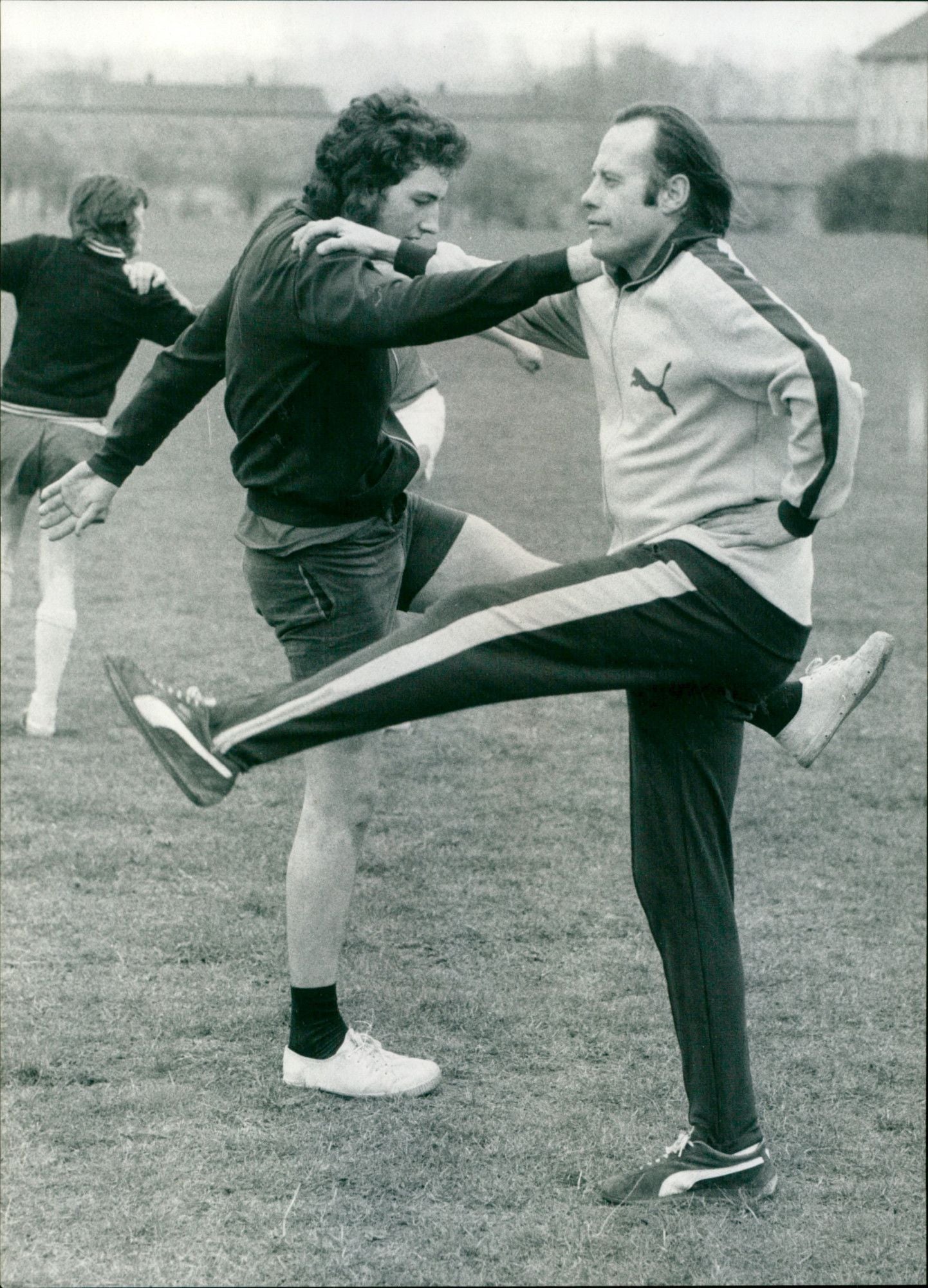 Former world record miler Derek Ibbotson demonstrates a warm-up exerci