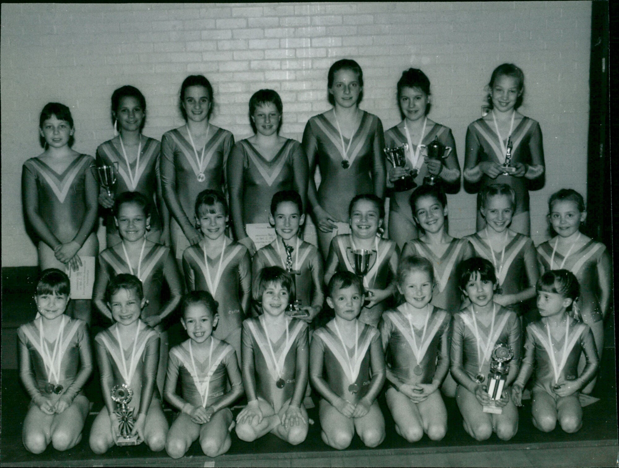 Winners of the gymnastics awards pose with their trophy. - Vintage Pho