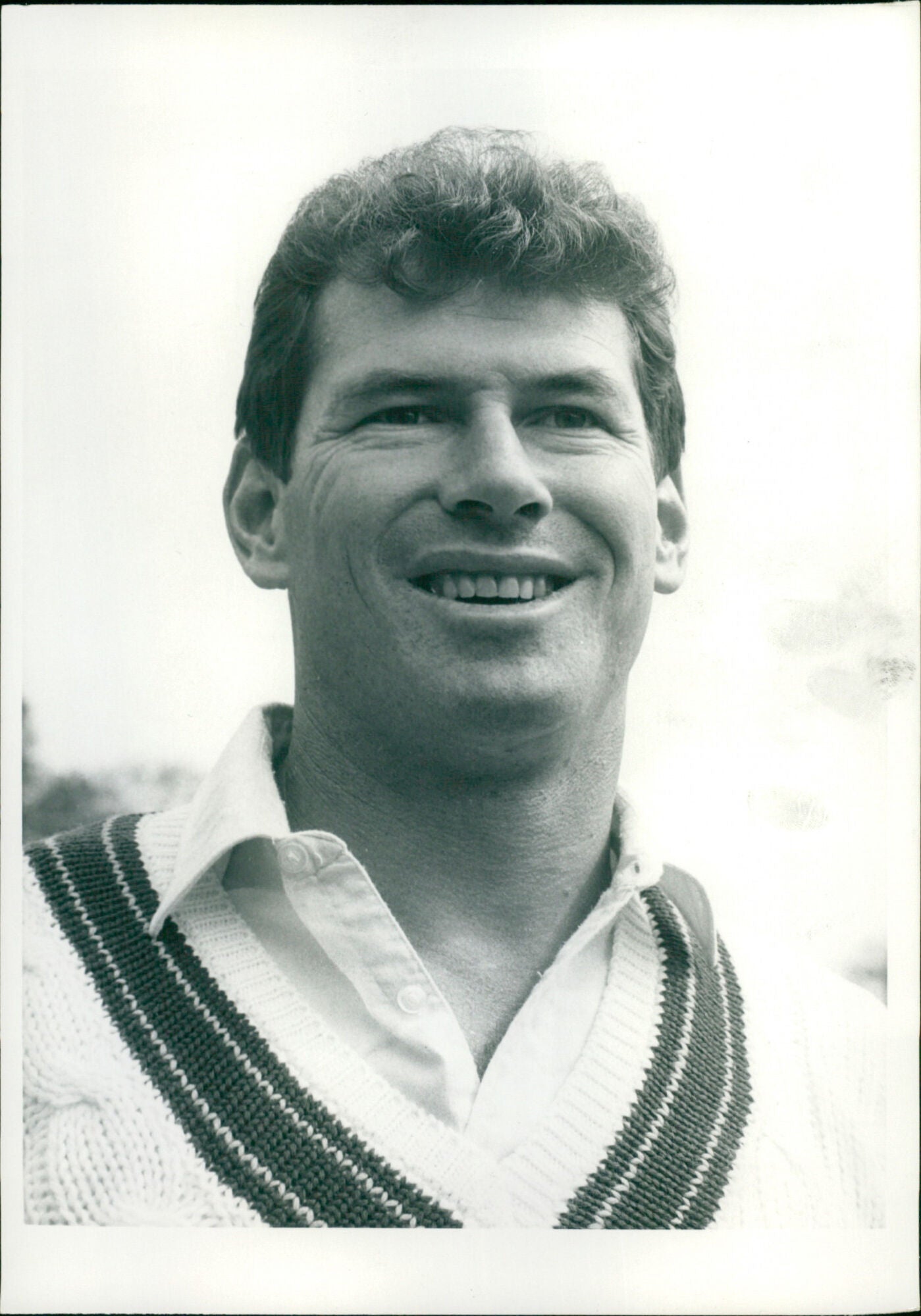 Neil Hawke of the Australian touring team smiles with a Coke in hand.