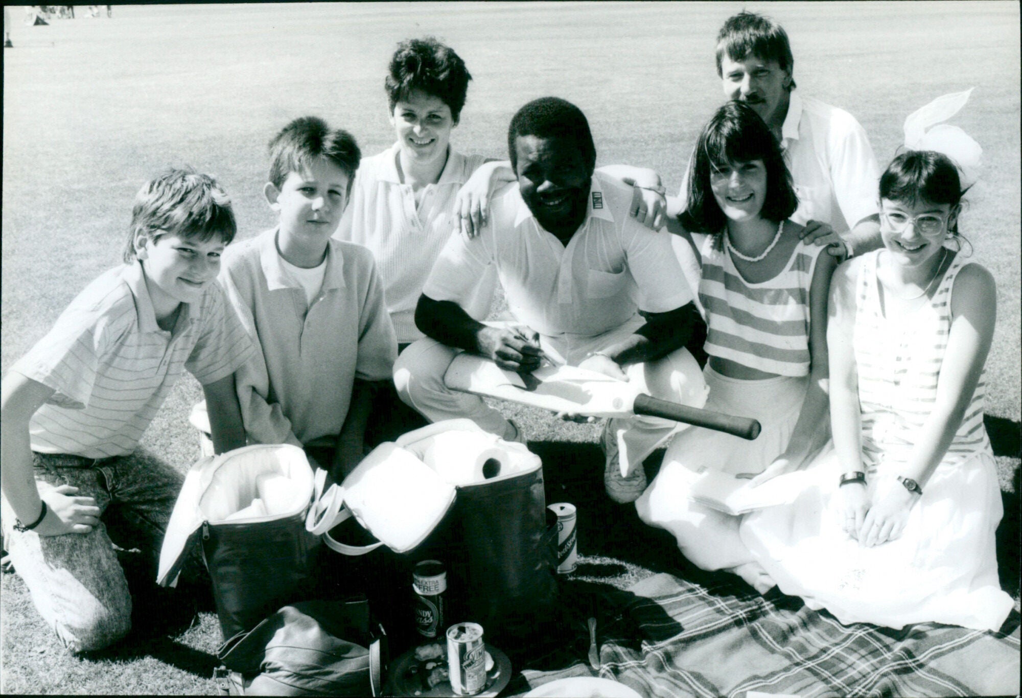 Former cricketer Malcolm Marshall taking time out to sign autographs.
