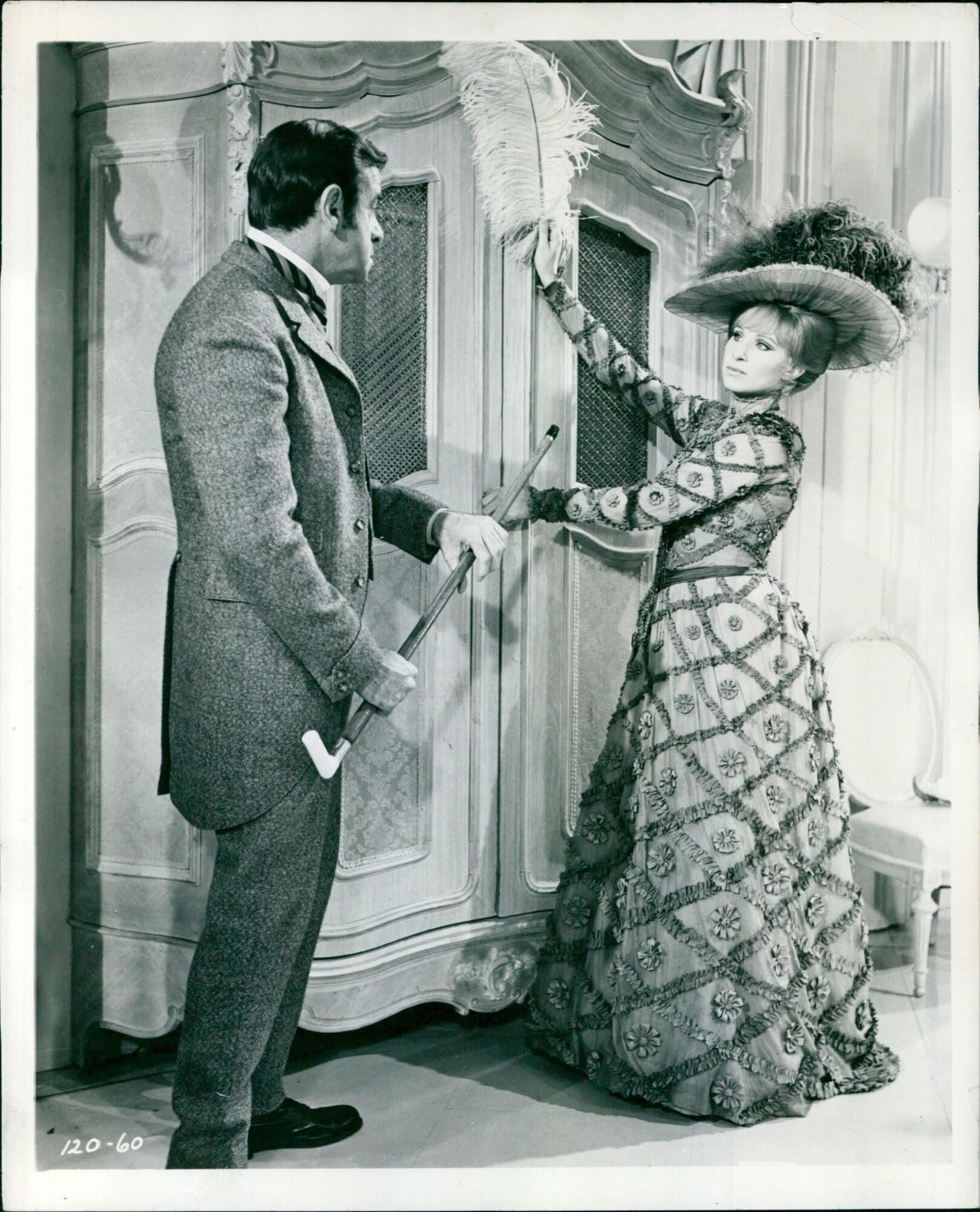 Barbara Streisand (Dolly Levi) attempts to protect Cornelius Hackl (Mi