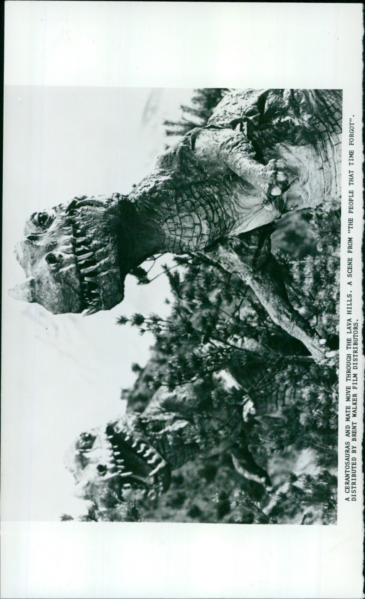 A Ceratosaurus and its mate traverse the lava hills. - Vintage Photogr