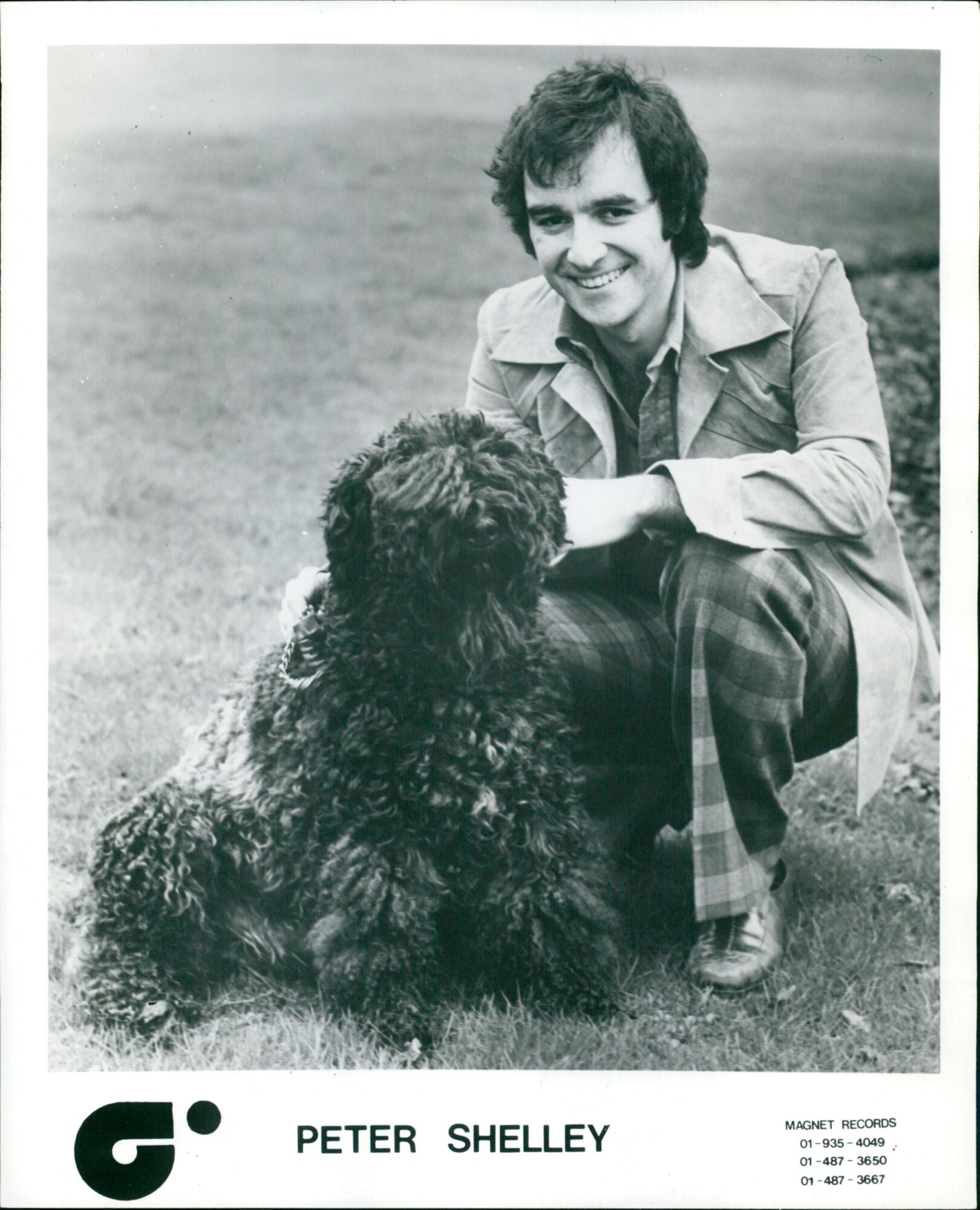 Dr. Peter Shelley of Magnet Records poses with a stack of records. - V