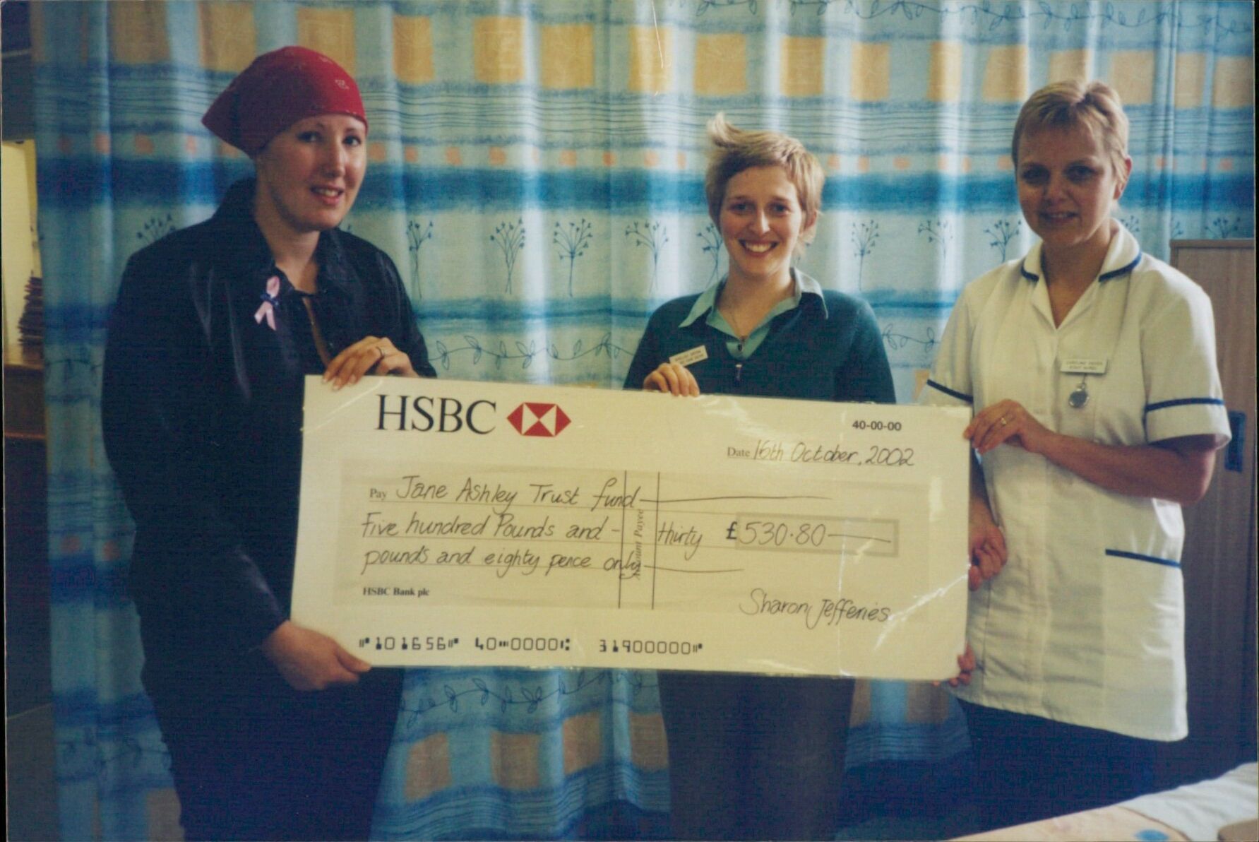 Cancer patient Sharon Jefferies presents her cheque for £530.80 to She