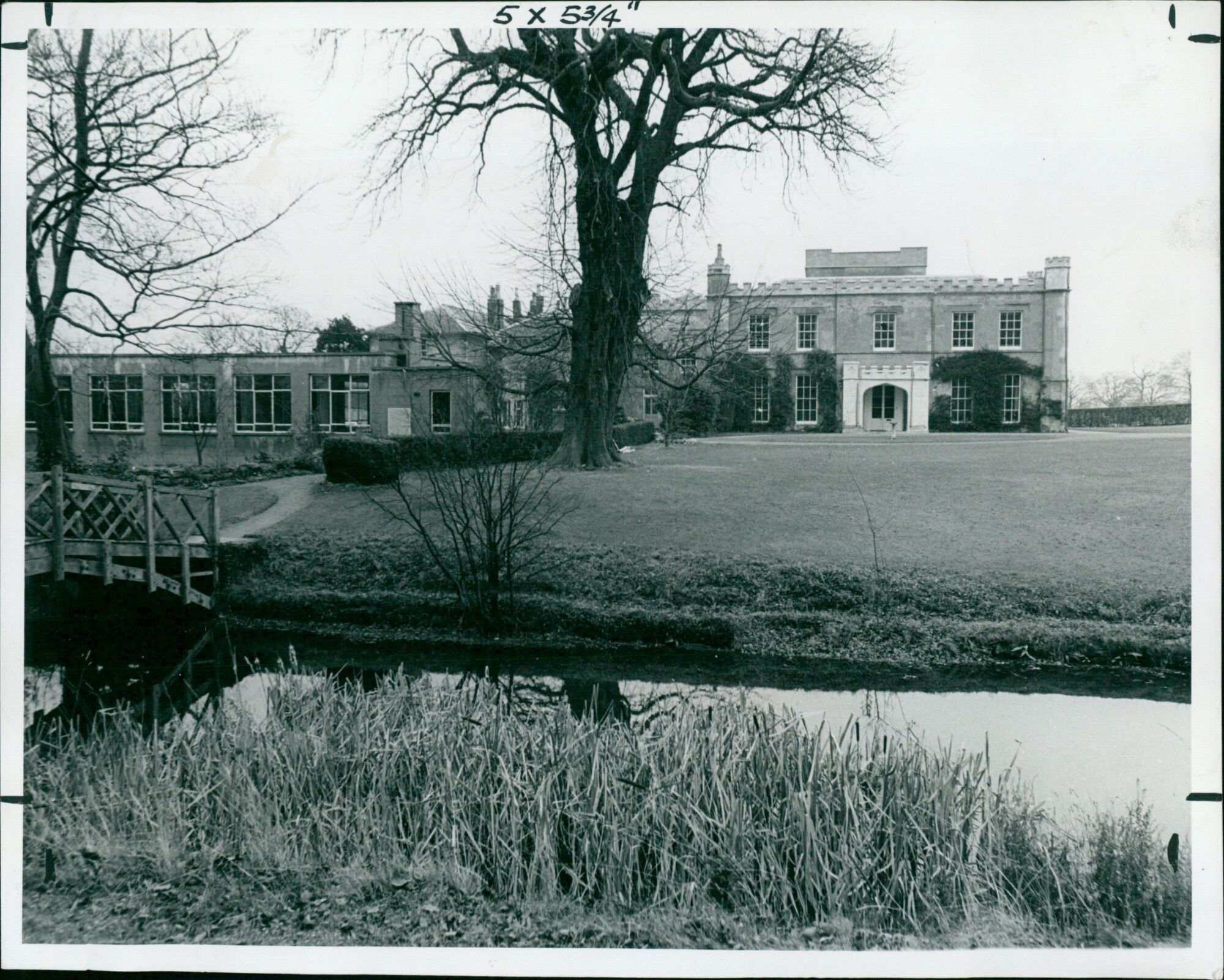 Students cross a moat to the early 19th century mansion of Holten Park