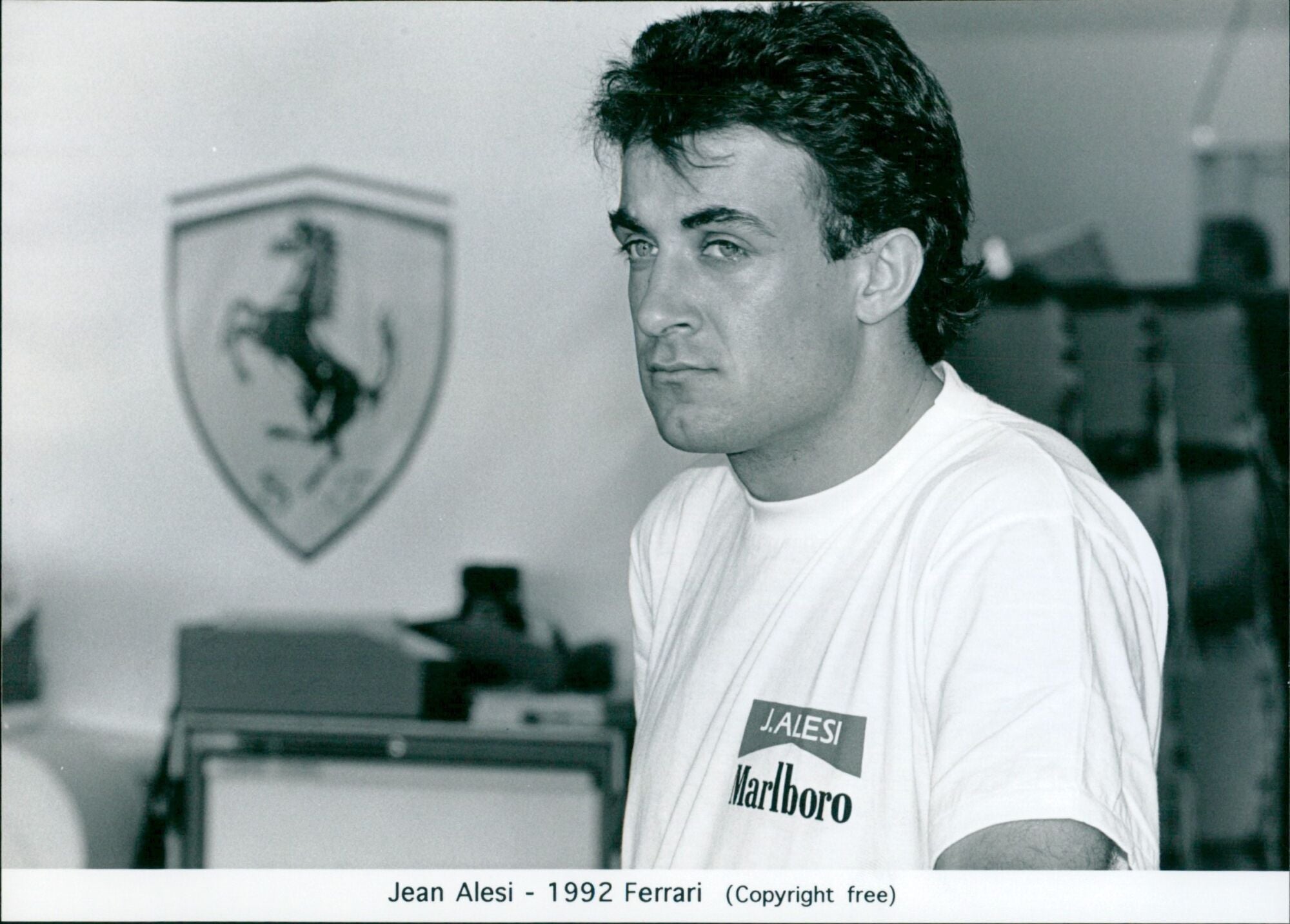 French racing driver Jean Alesi poses with a Marlboro-sponsored Ferrar