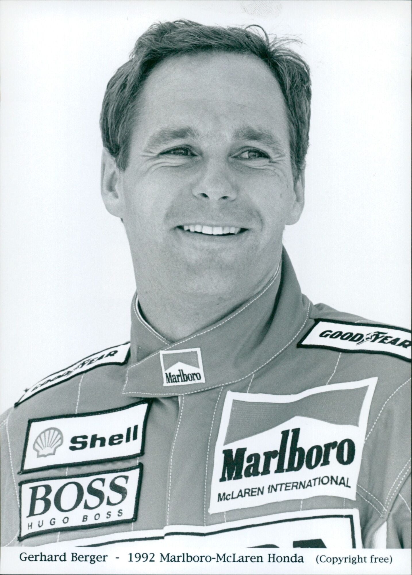 Racing driver Gerhard Berger poses with the Marlboro-McLaren Honda car