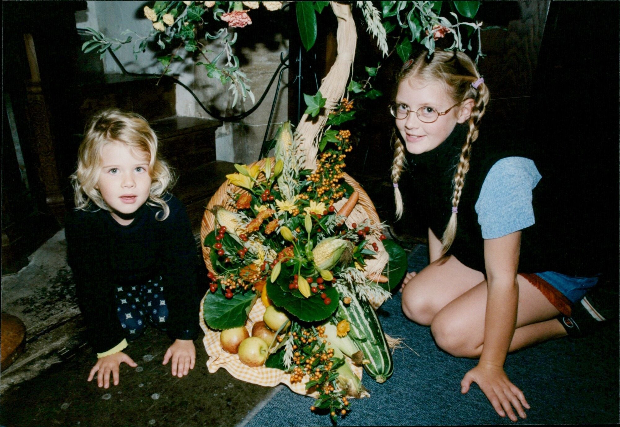 Zoe Fowler, age 4, and her sister Shauner, 9, view flower arrangements