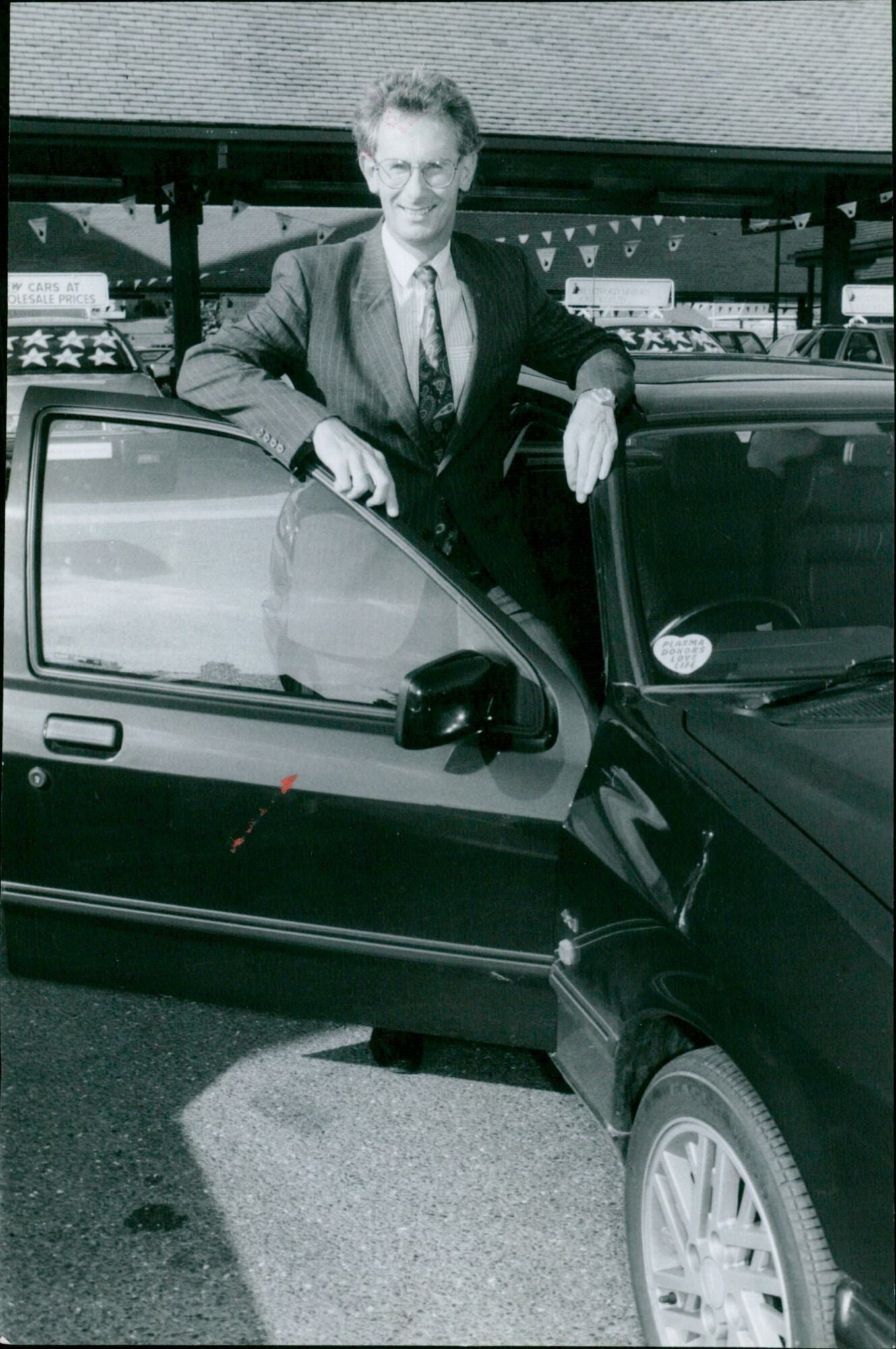 Charles Eveson with a Ford Sierra at Hartford Motors. - Vintage Photog
