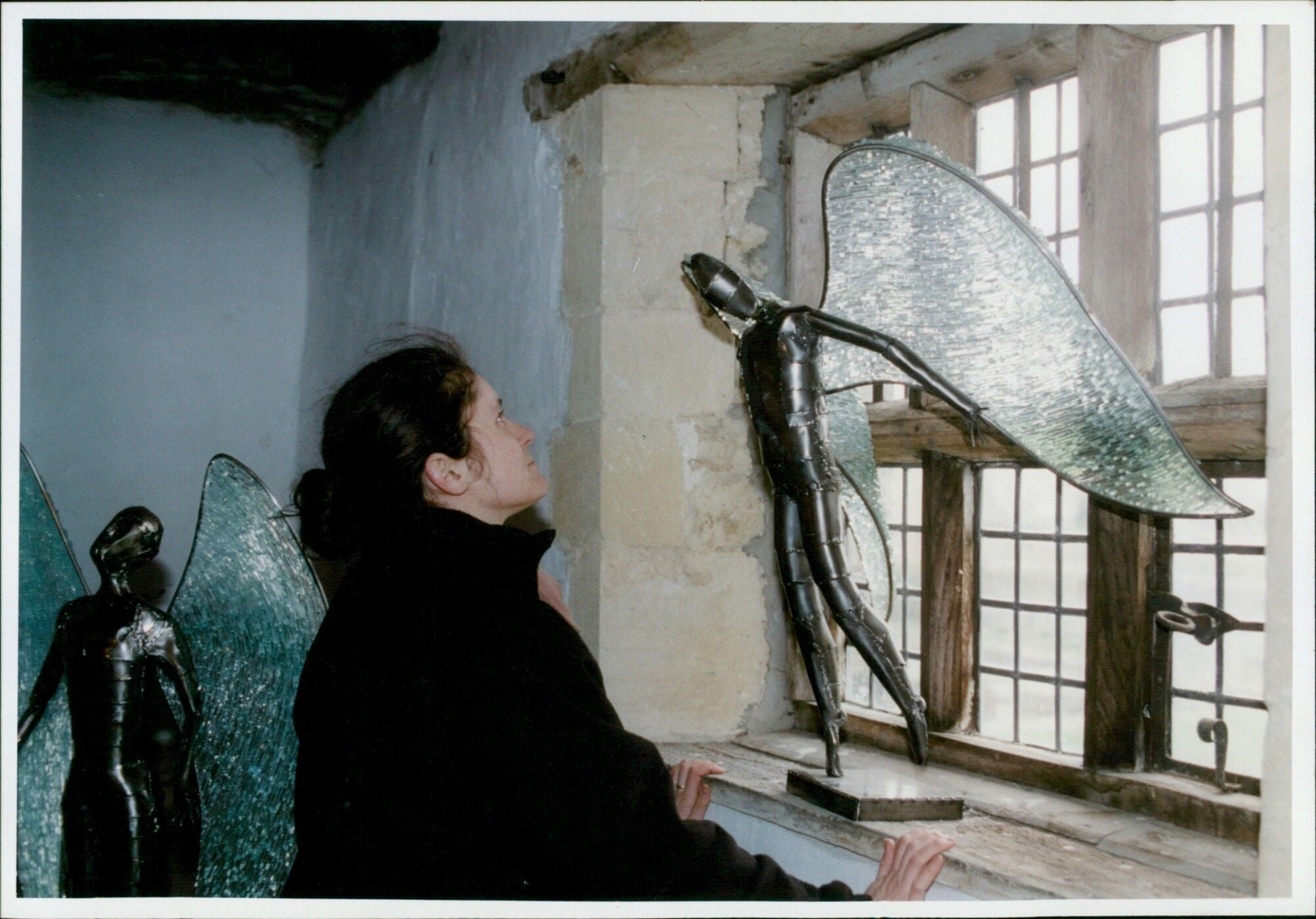 Ann Swarbrick and Nicola Blake pose with the sculptures of angels, nym