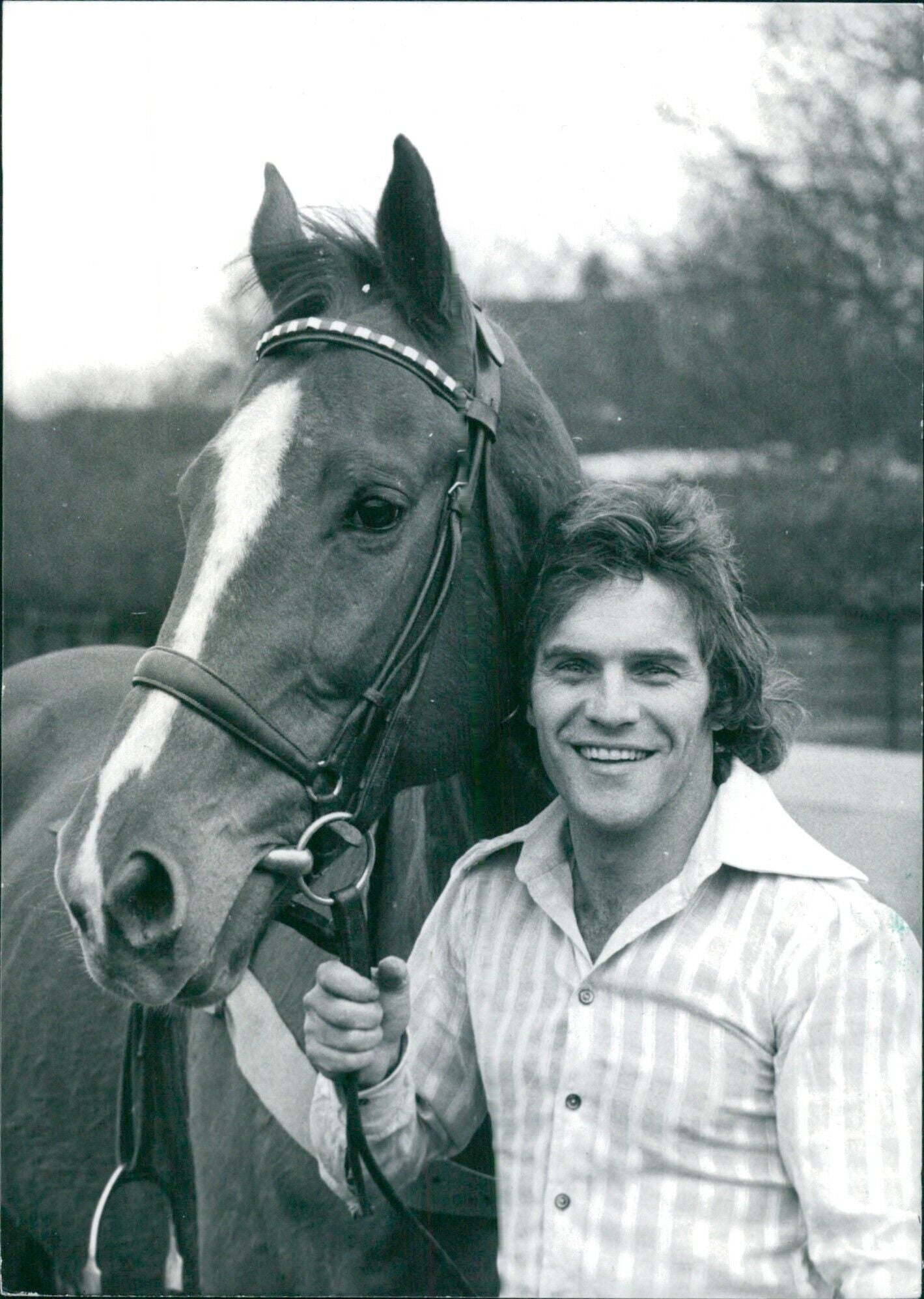 British comedian Freddie Starr enjoying a ride on a borrowed horse, on