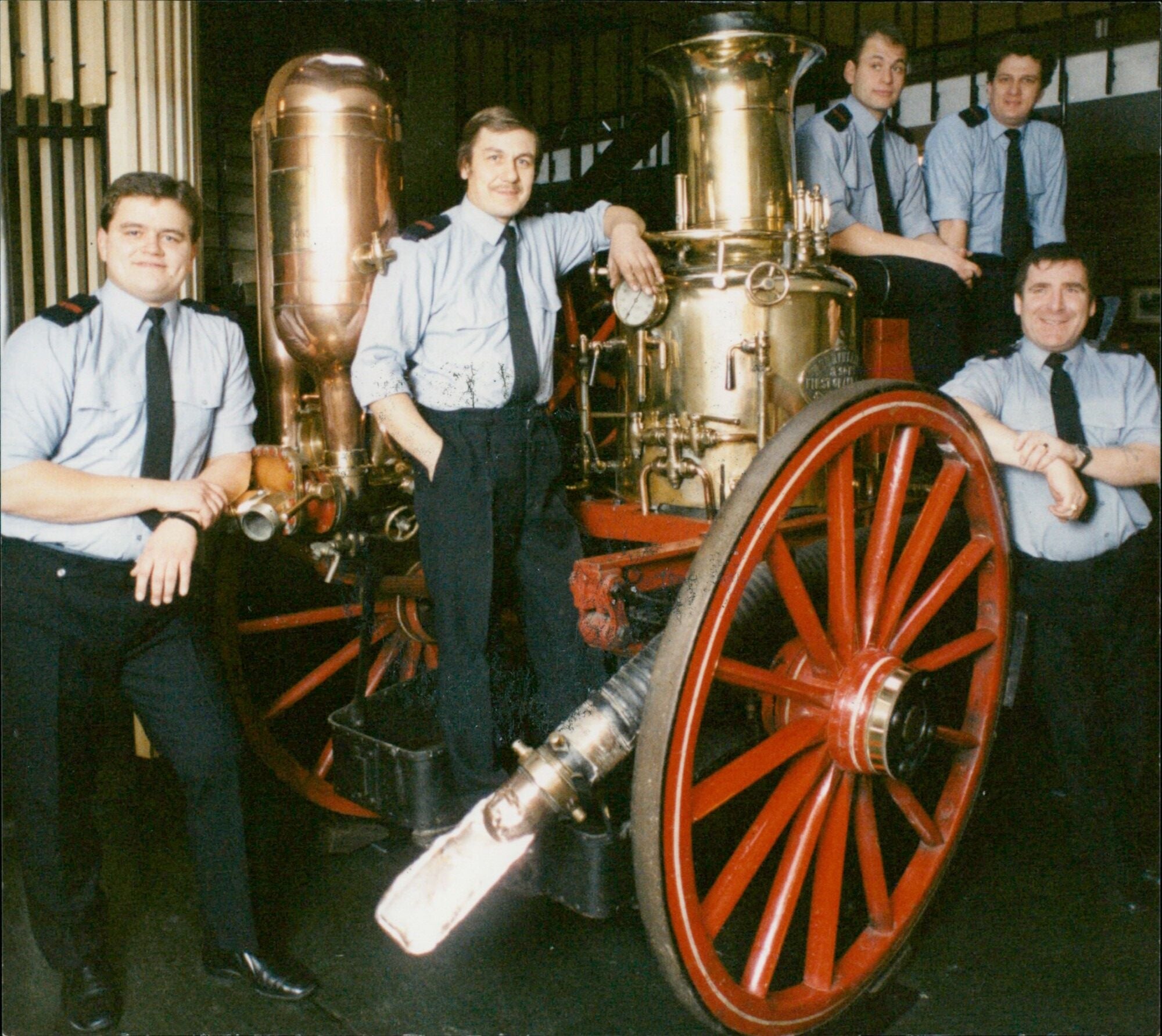 Steam engine restoration team pose for a photograph in front of the 18