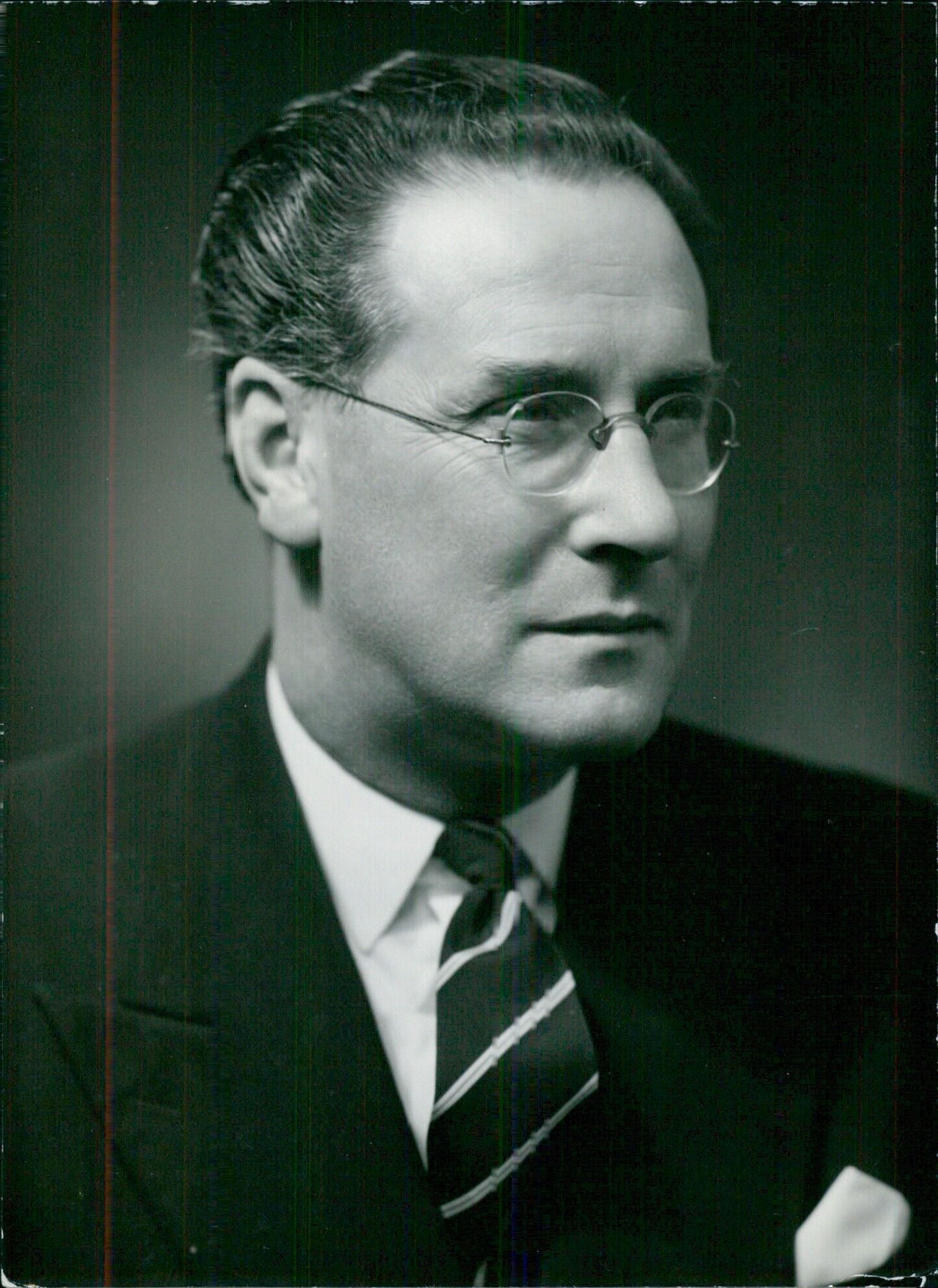 Kenneth Adam, Controller of B.B.C. Television Programmes, poses for a