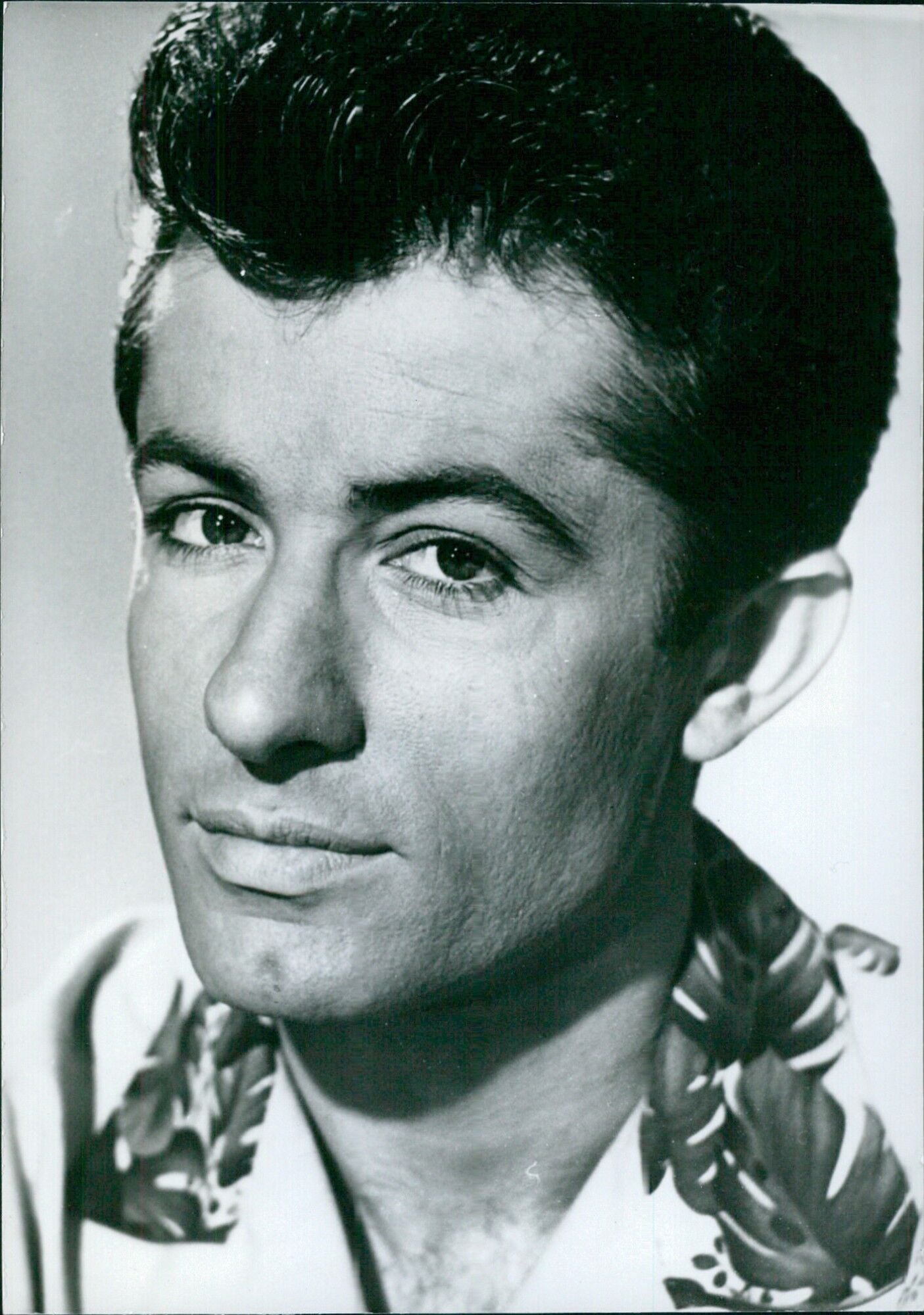 American actor George Chakiris poses for a portrait in 1964. - Vintage