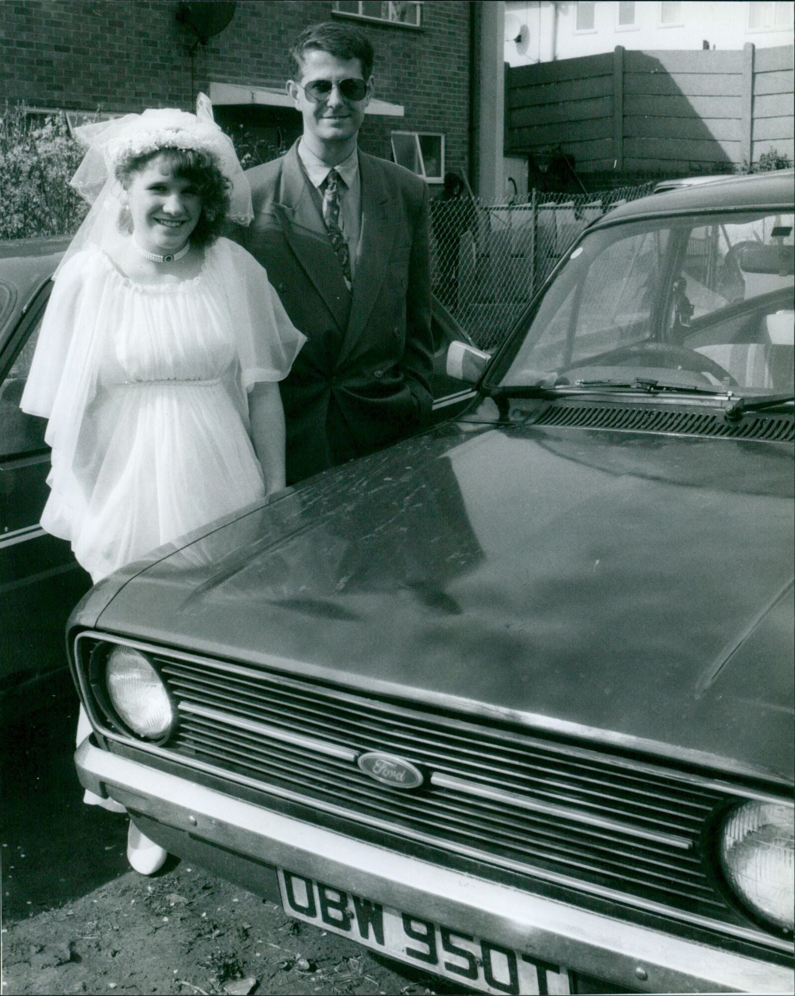 Newlyweds Mary Ann Kelly and Trevor Prentice pose with their Ford Esco