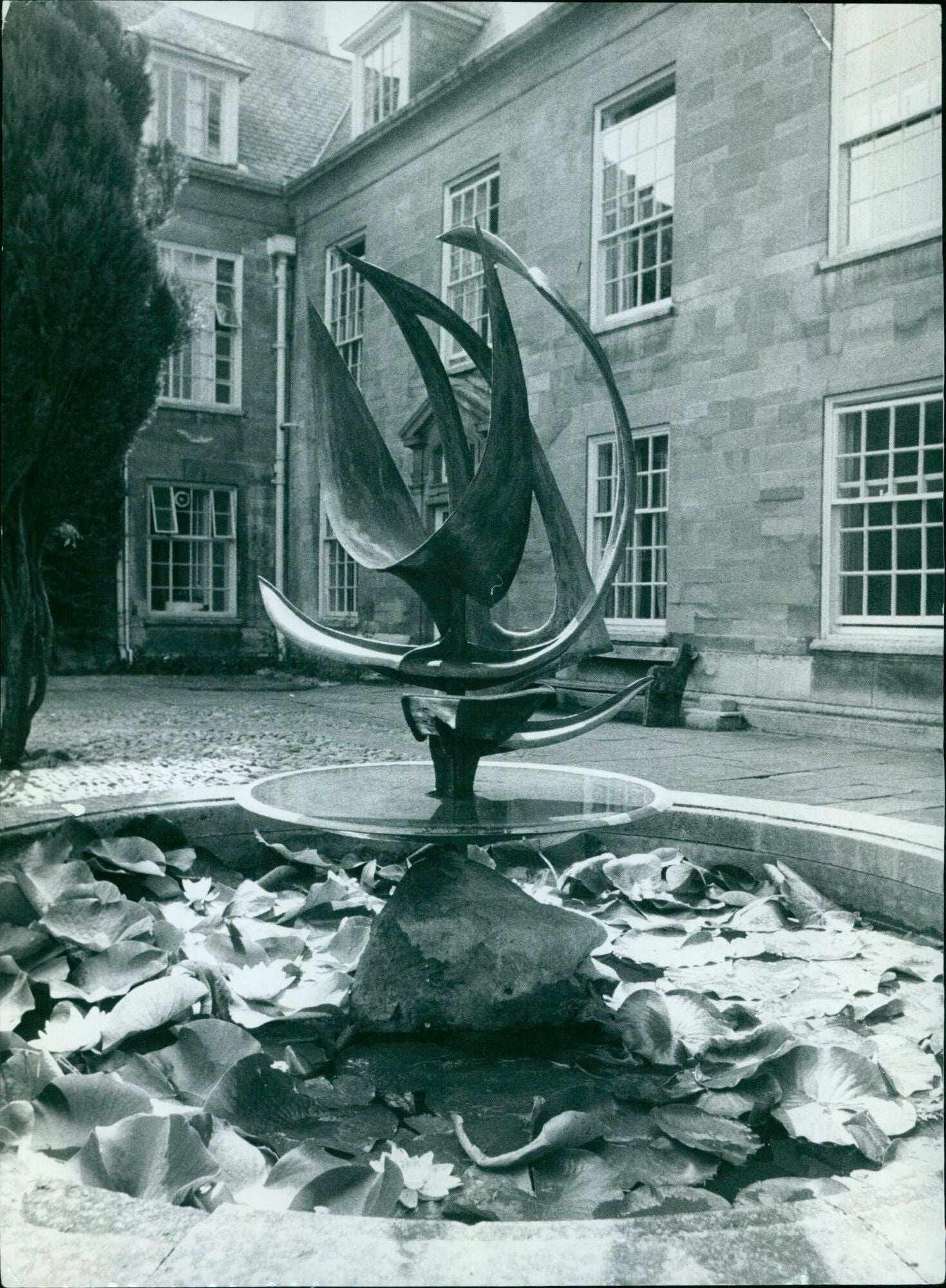 Visitors enjoy the fountain at Holywell Manor on August 28, 1976. - Vi