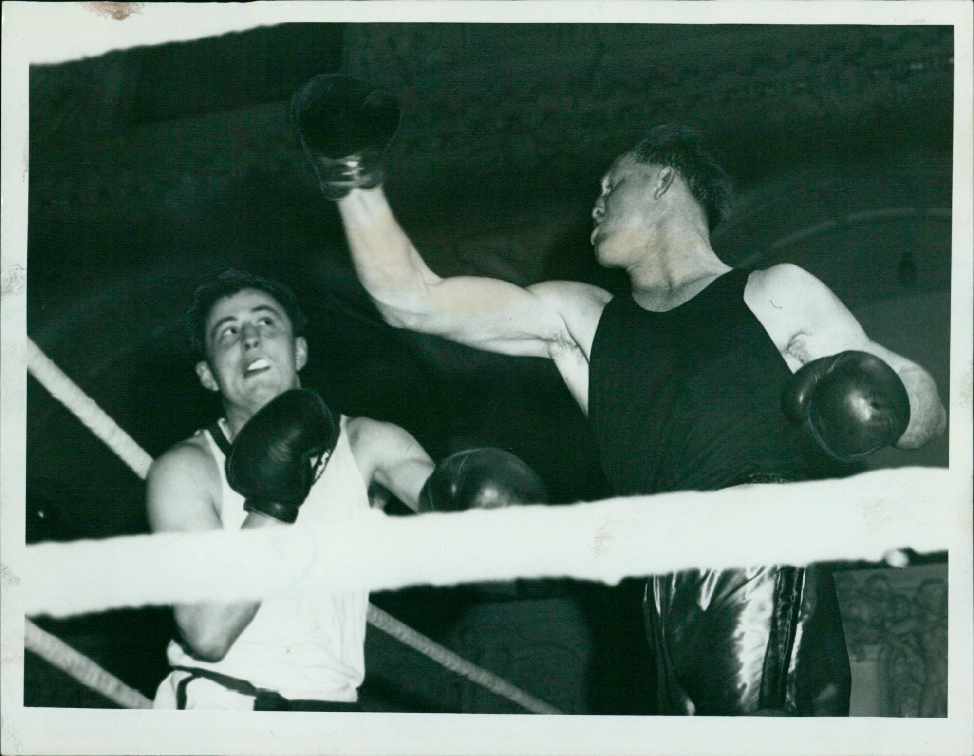 Oxford University boxing captain R. B. Atkinson (left) watches a right