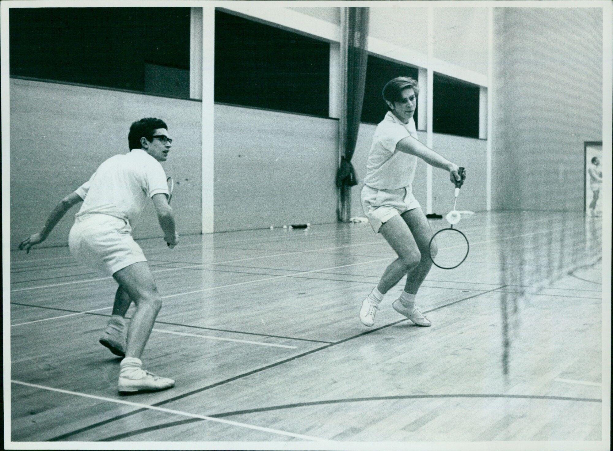 Badminton players compete in a match on January 14, 1970. - Vintage Ph
