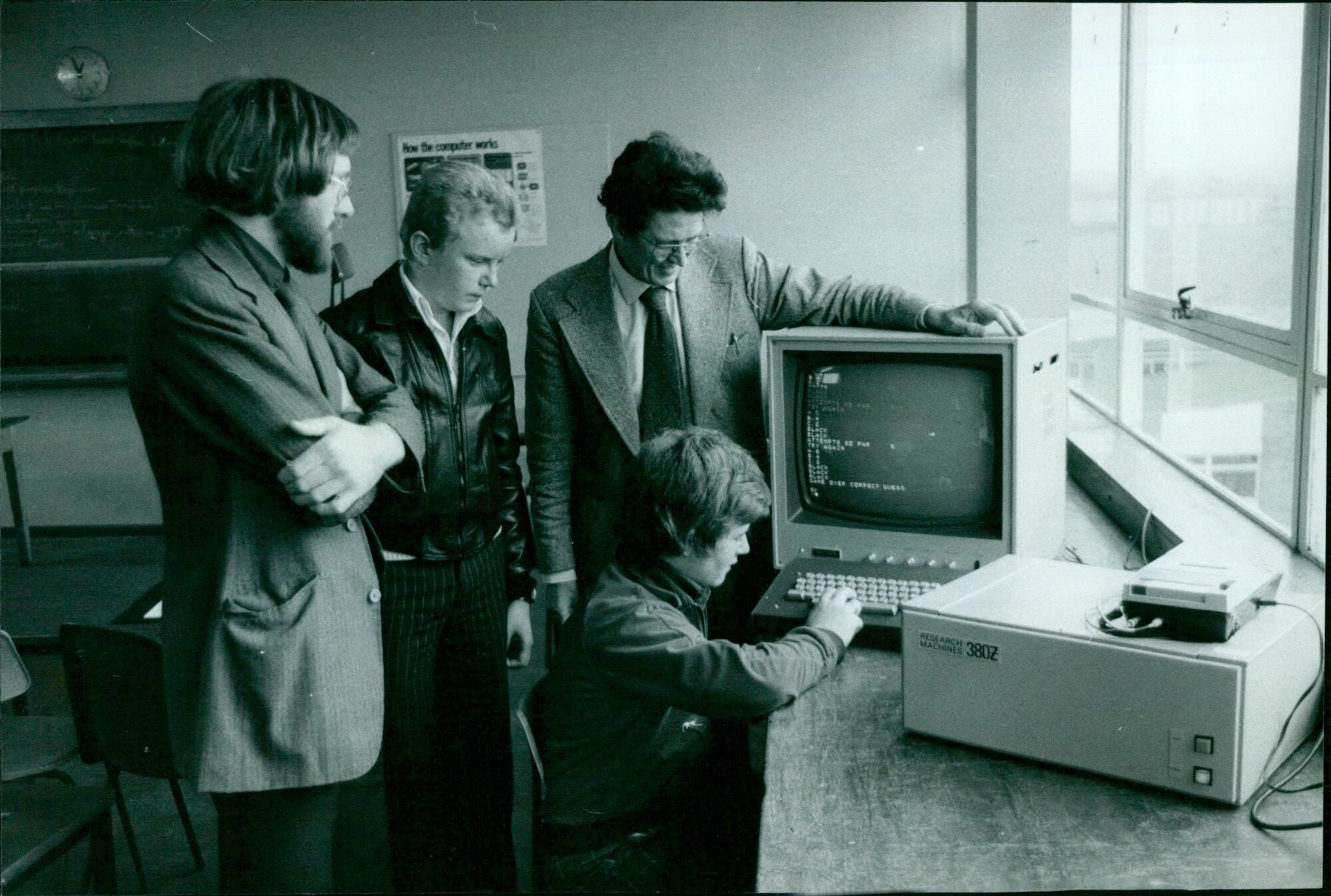 Nigel Luke, 14, operates a new machine at Redefield school, watched by