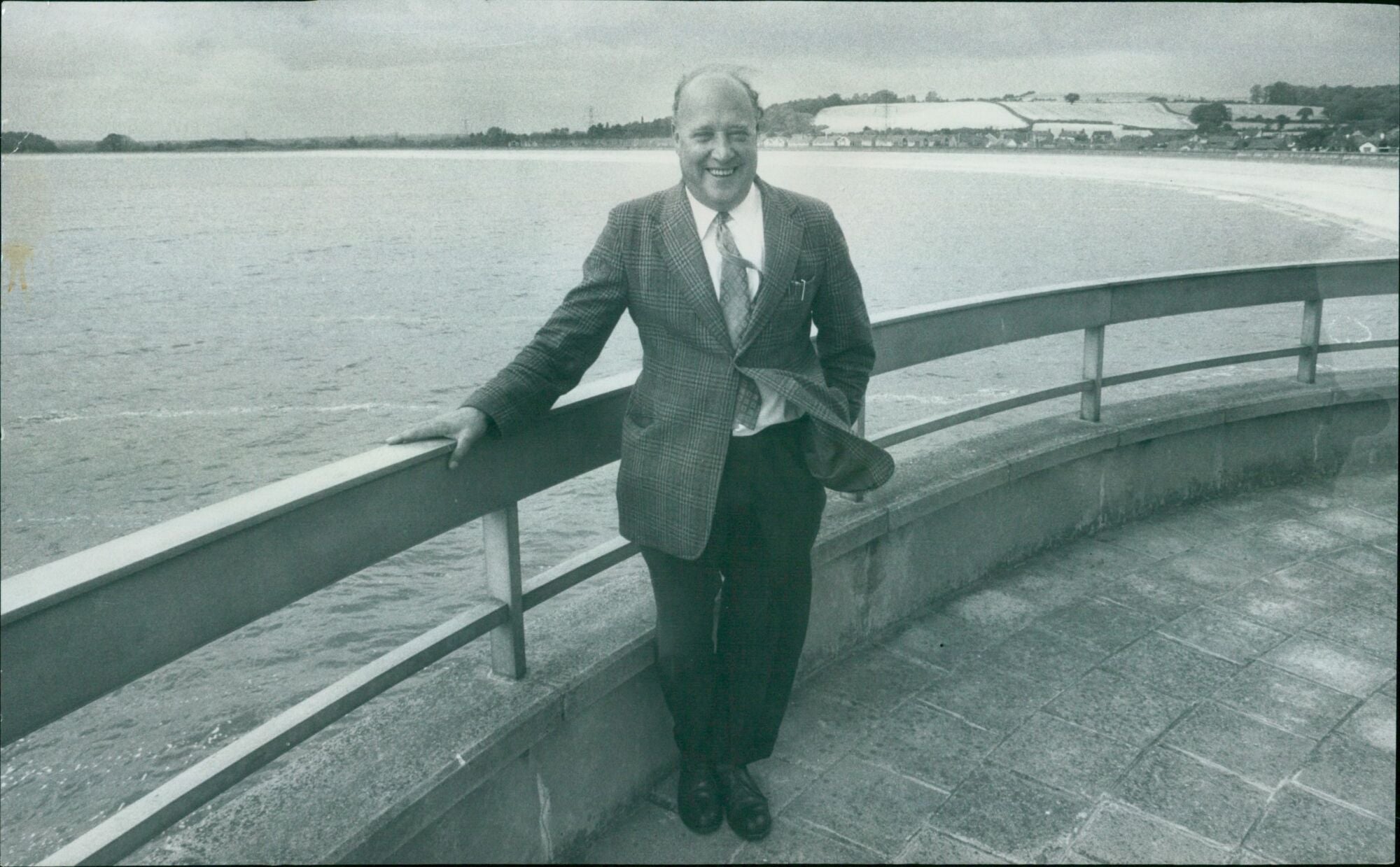 Mr. Les Waite stands beside the Farmoor reservoir, highlighting the di