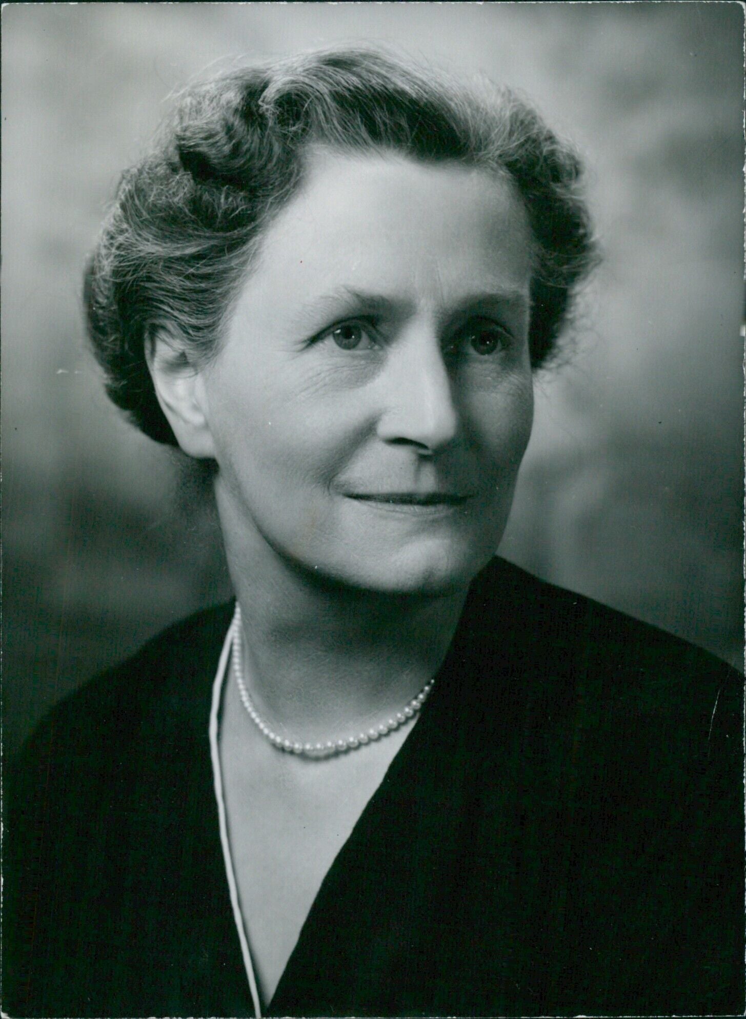 Miss A.M. Kynaston, Principal of Queen's College in London, poses for