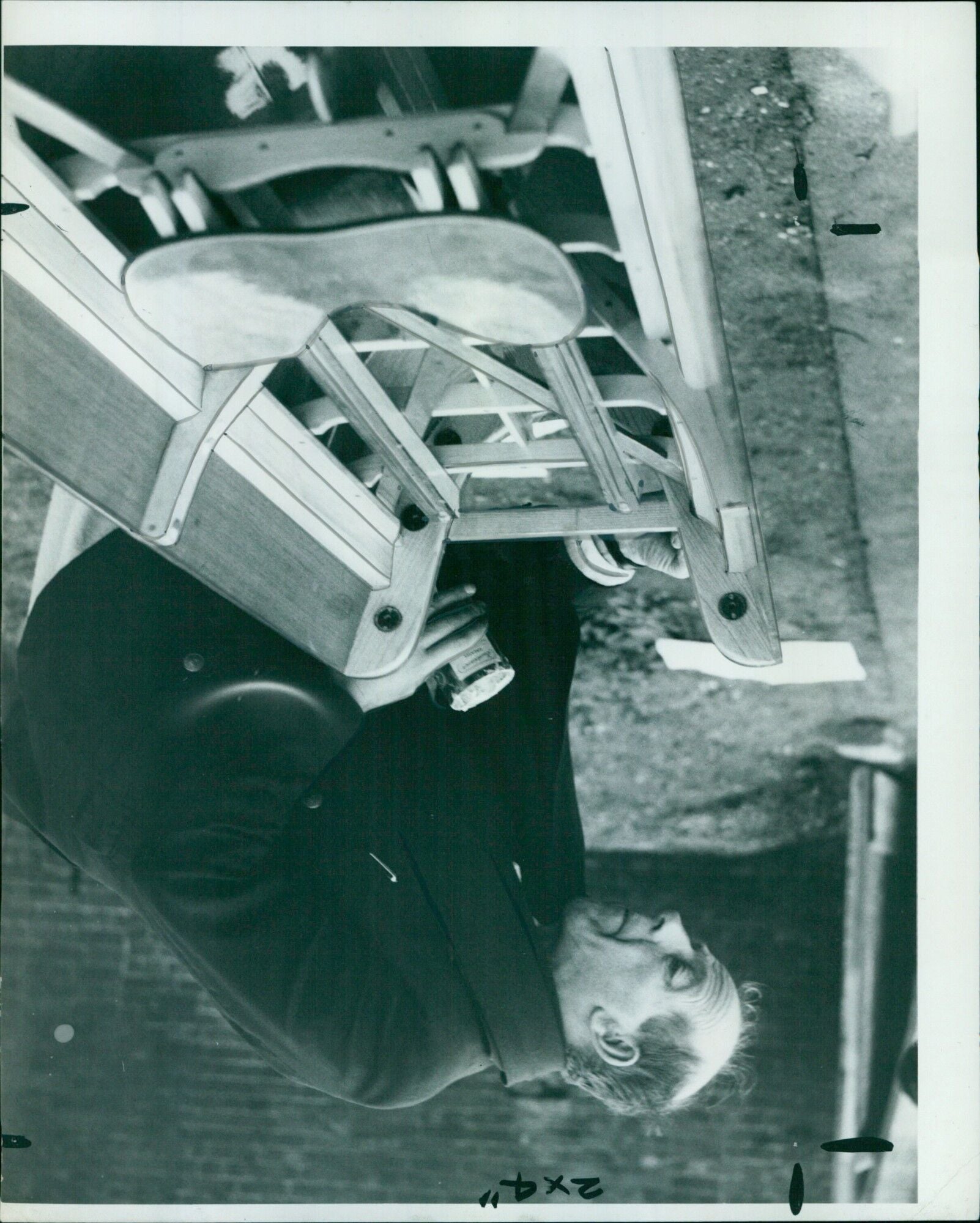 Group-Capt. H. R. A. Edwards grease a bulkhead during construction of