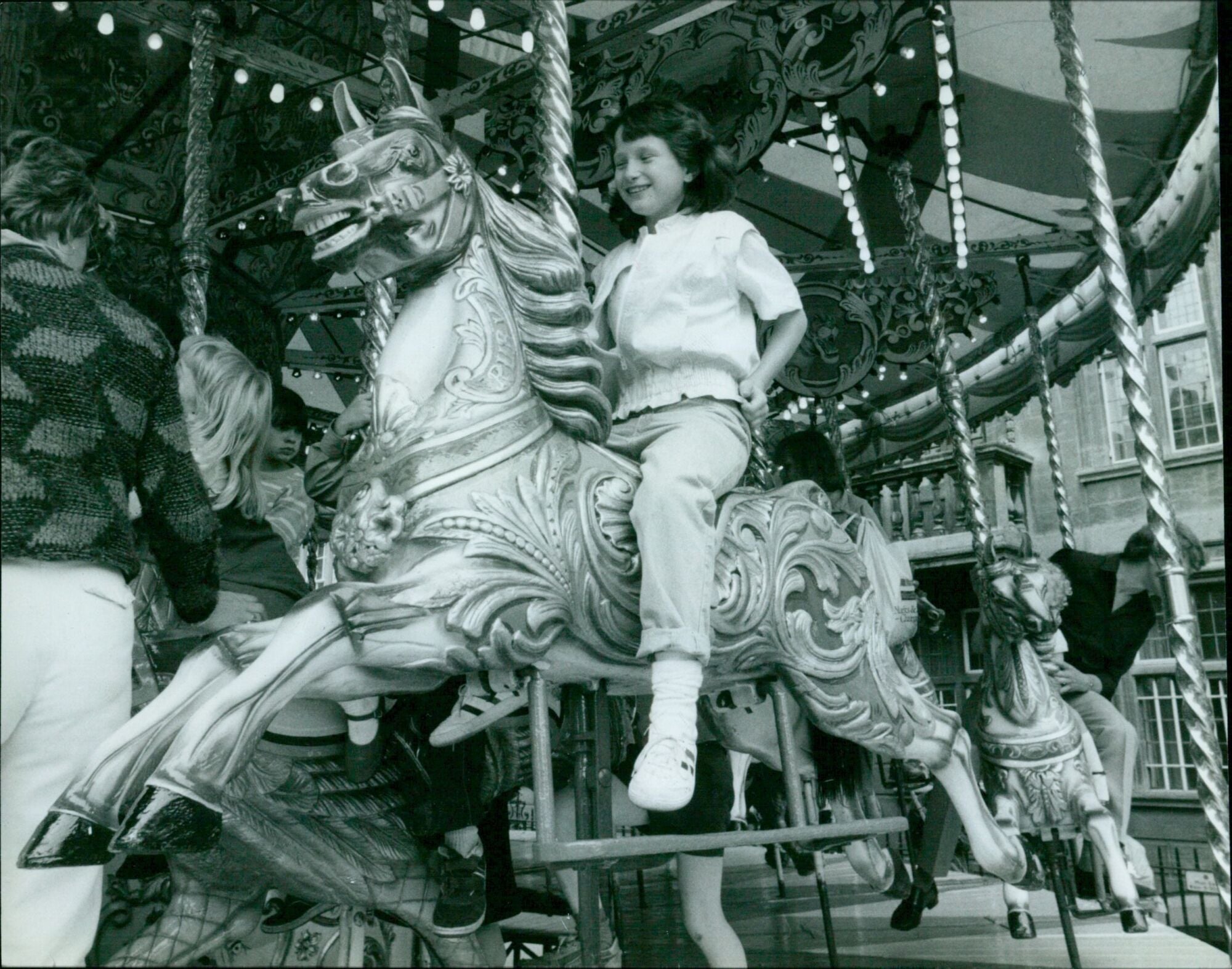 Joanna Hart enjoys a ride on the Galloping Horses. - Vintage Photograp