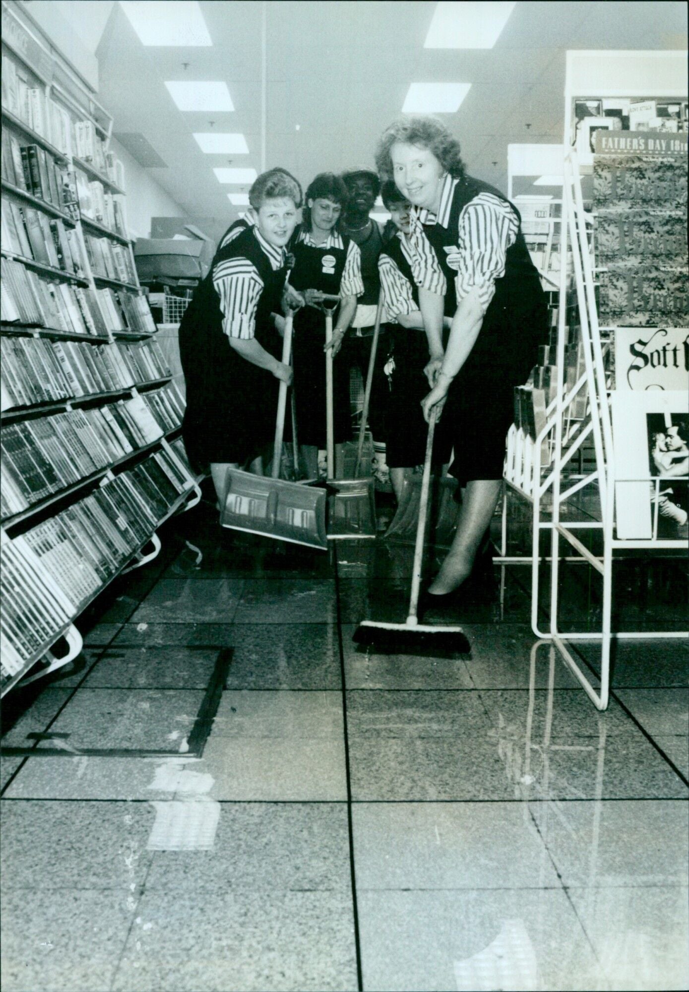 Staff members of Woolworths at Cowley Centre clean up after a flood.