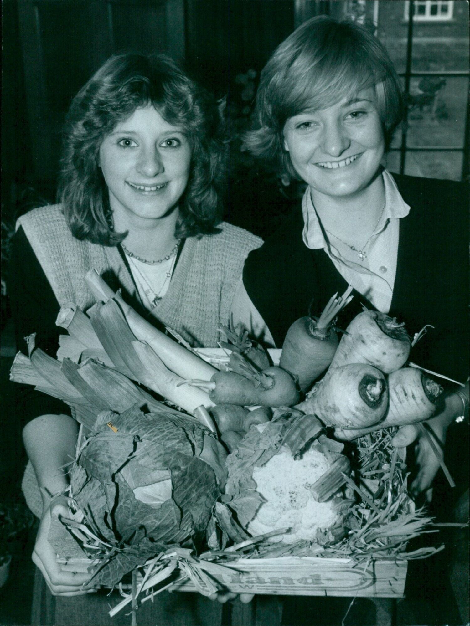 Teenagers Alison Finch and Helen Knowles showcase vegetables at the He