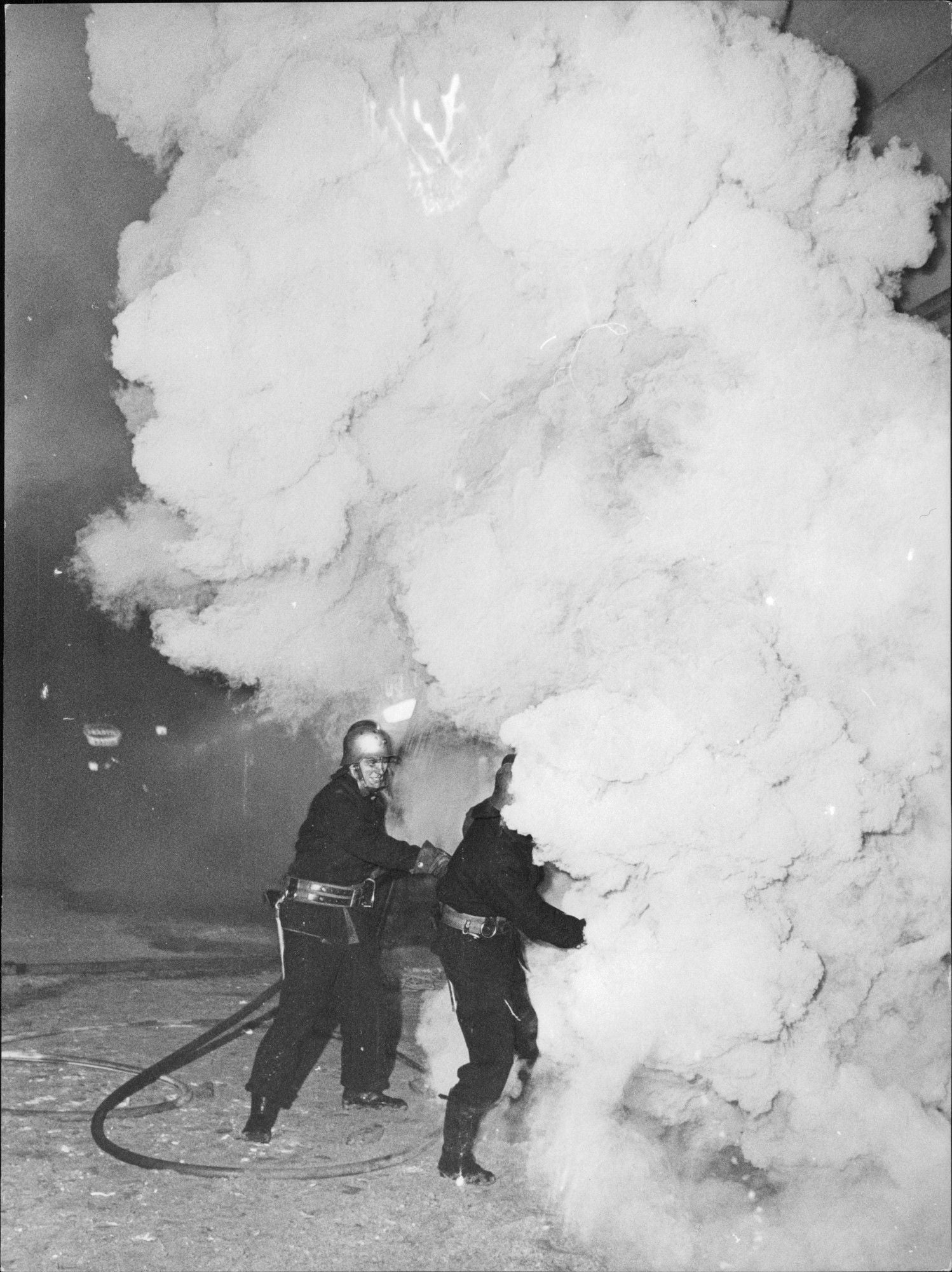 Firefighters fight to overcome the massive smoke masses that emit when